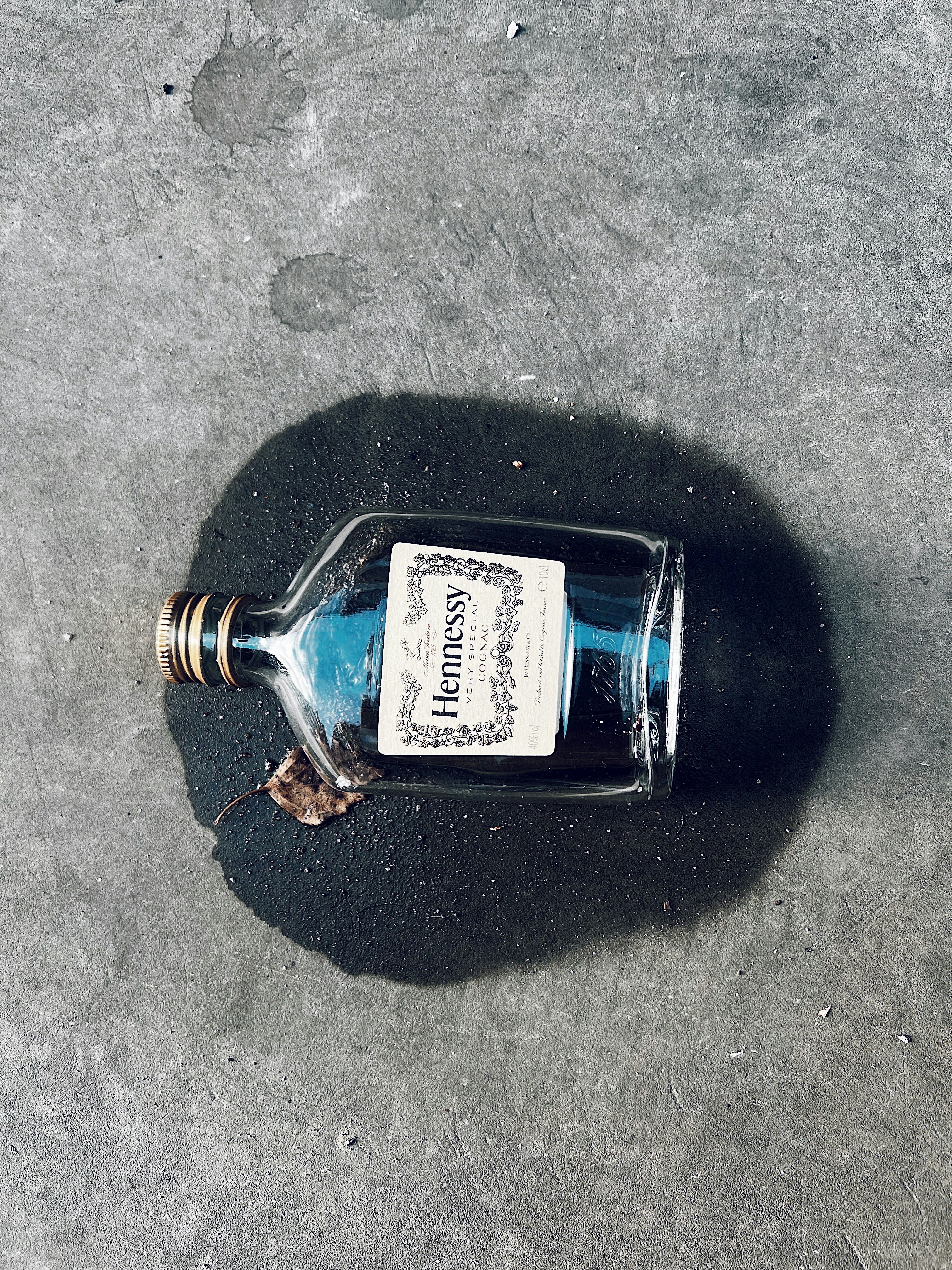 a bottle with a label on it sitting on the ground