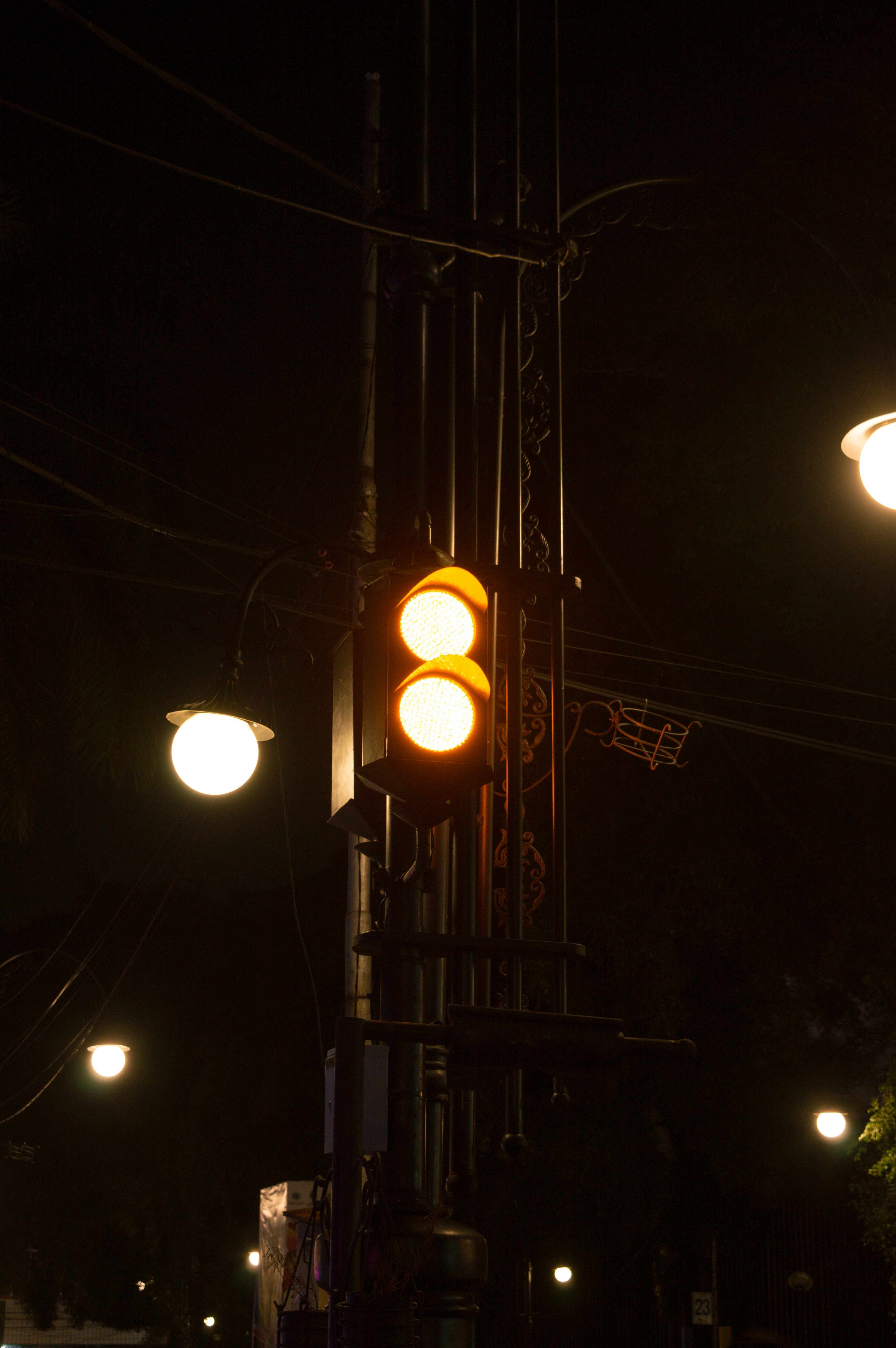 Amber Signal Amid Night Currents: A Quiet Streetlight Portrait