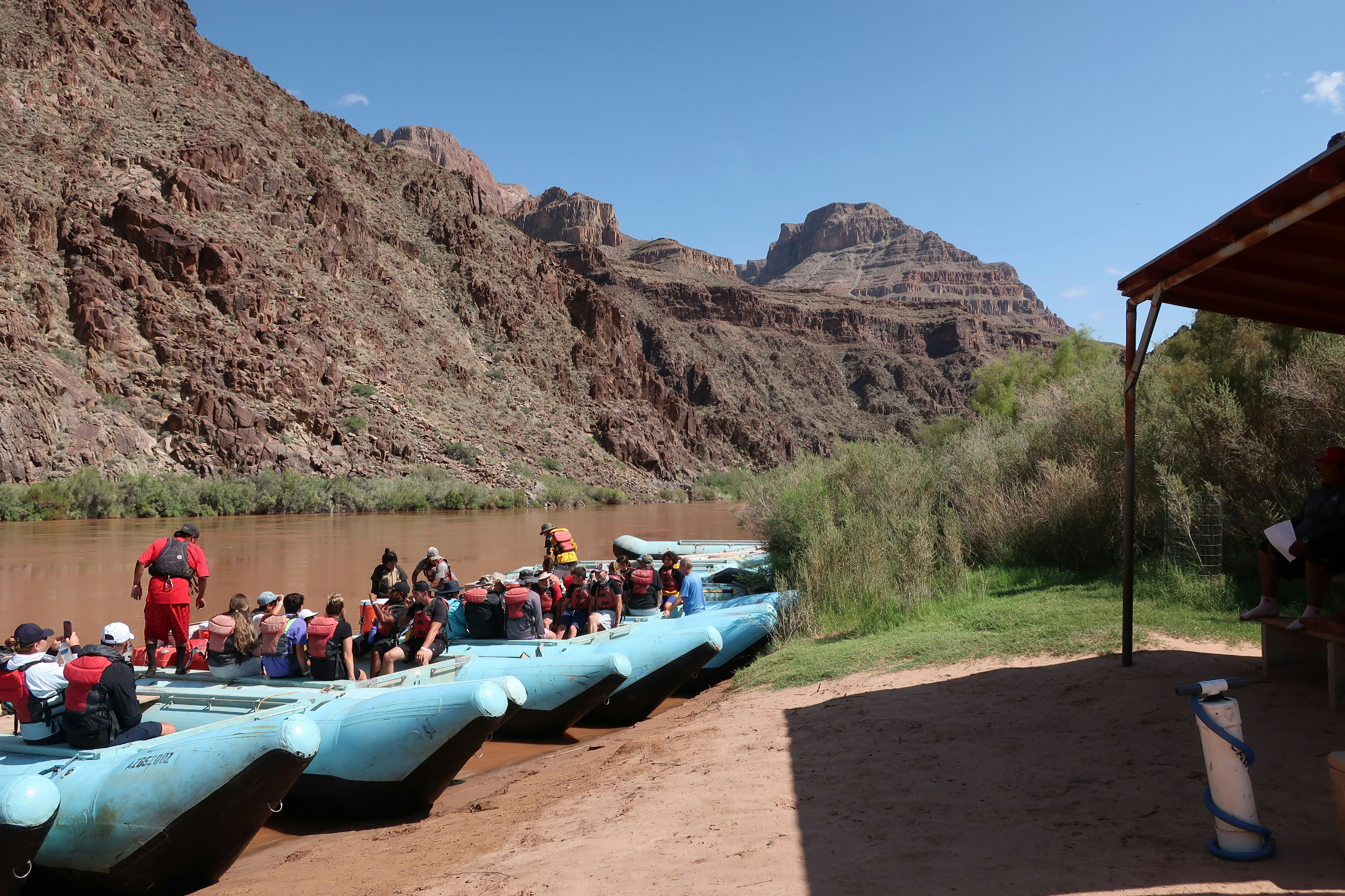 A group of people standing on top of a blue raft photo – Free Human ...