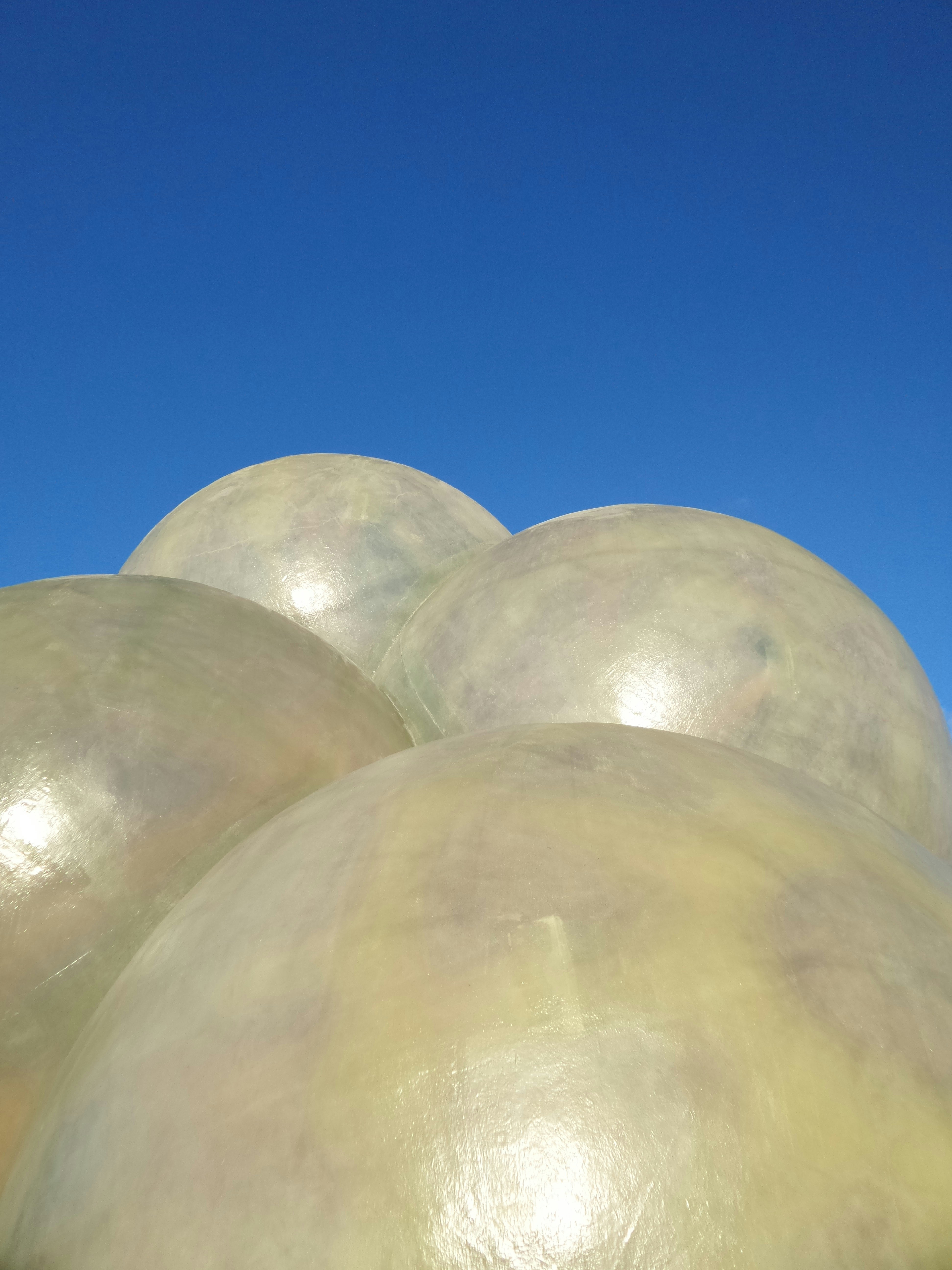 A group of large white balls sitting on top of each other photo – Free ...