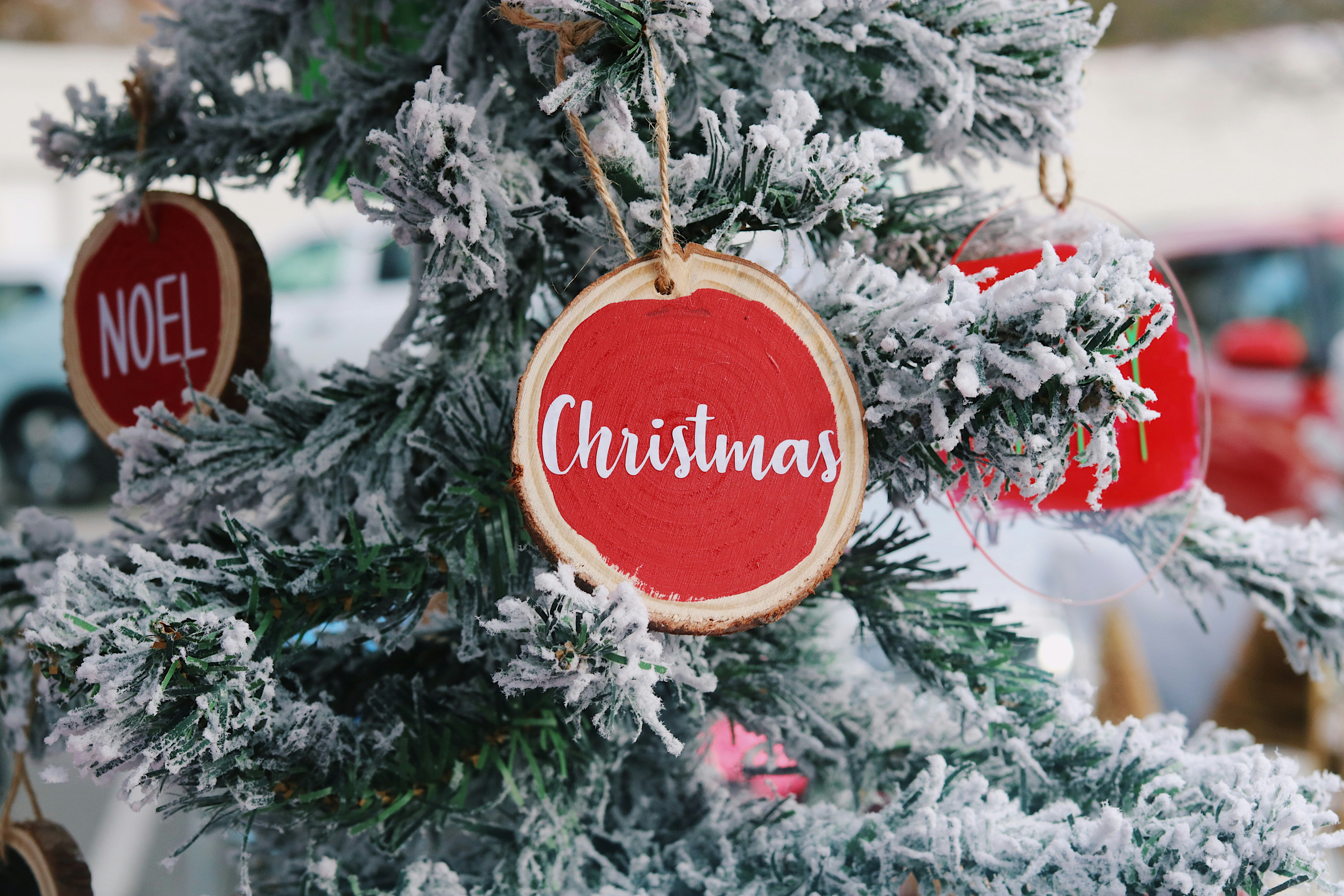 Frosty Christmas Ornaments: Red Circular Signs on a Snow-Dusted Fir