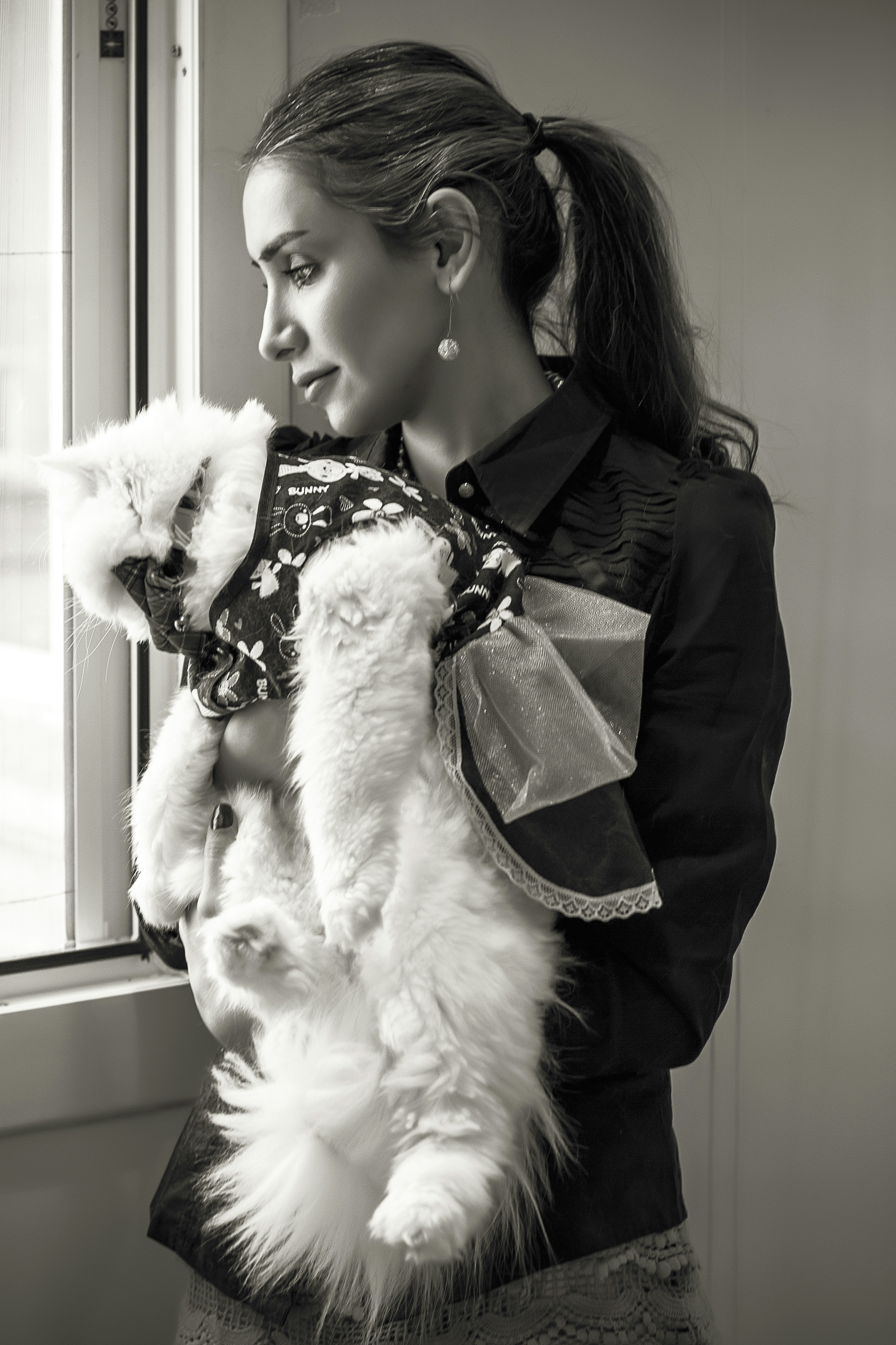 Portrait by the Window: A woman with a plush, patterned scarf and fur stole gazes off to the left
