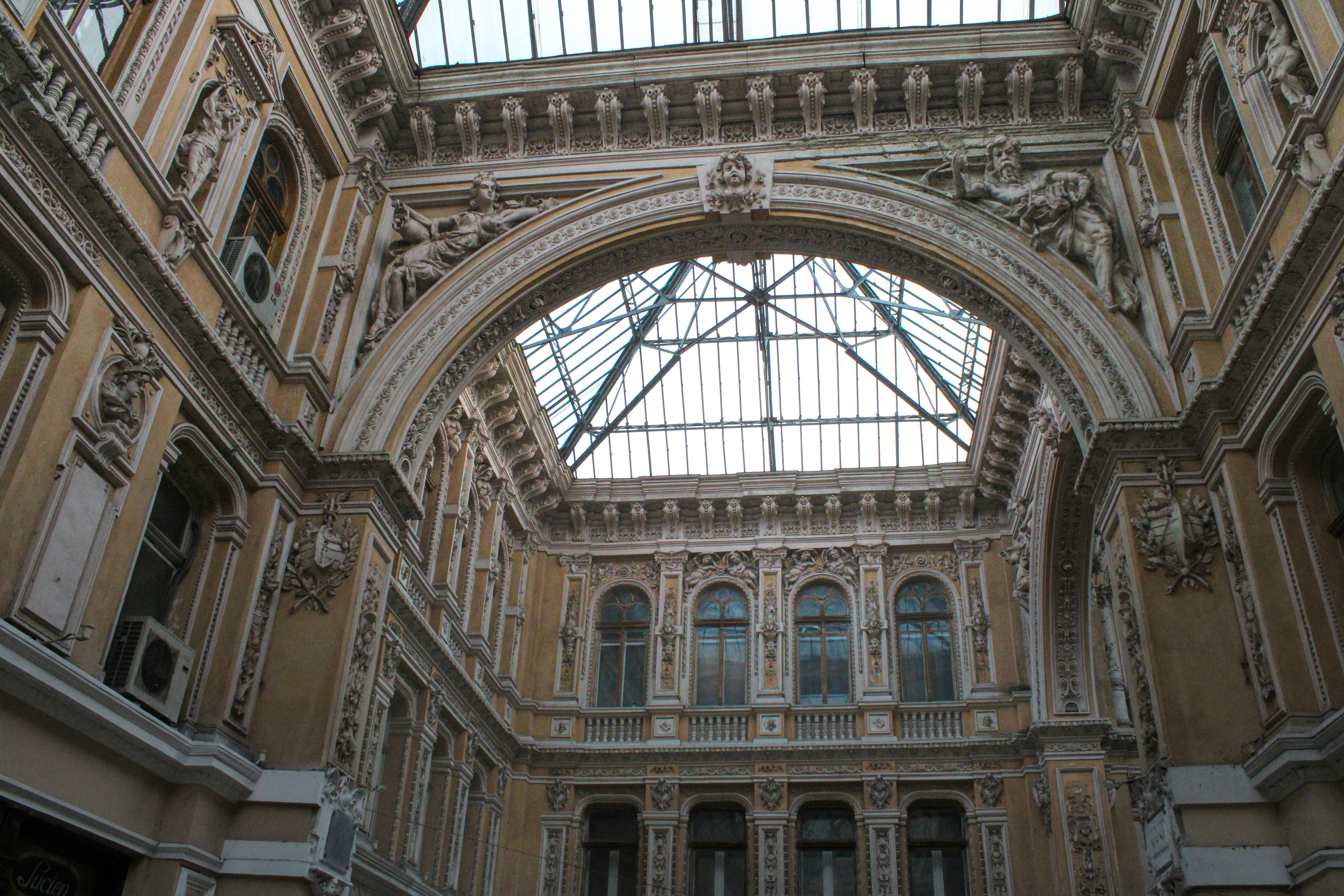 Glass-Ceiling Cathedral: Sunlit Atrium Framed by Ornate Arches