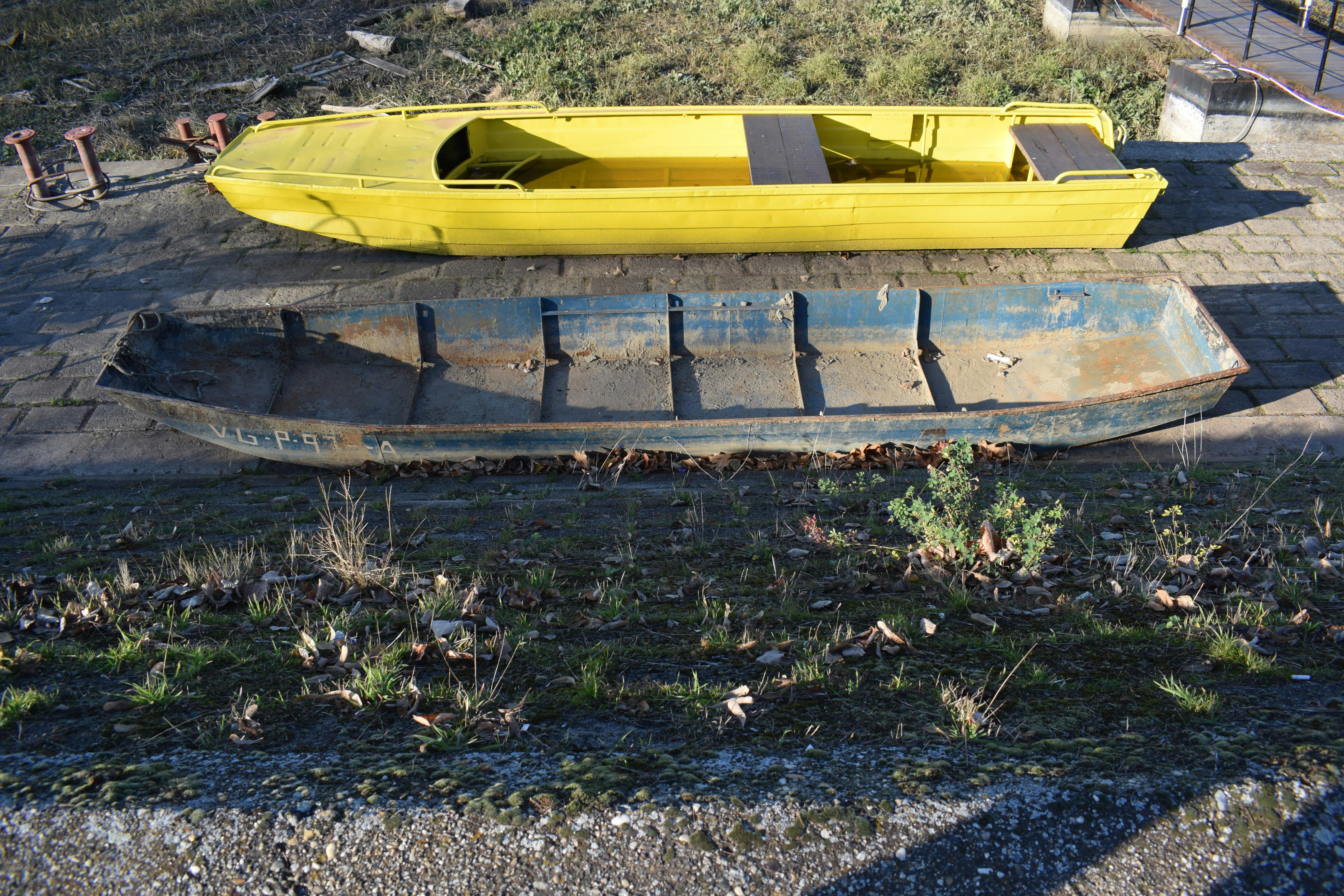 a yellow boat sitting on top of a dirt field