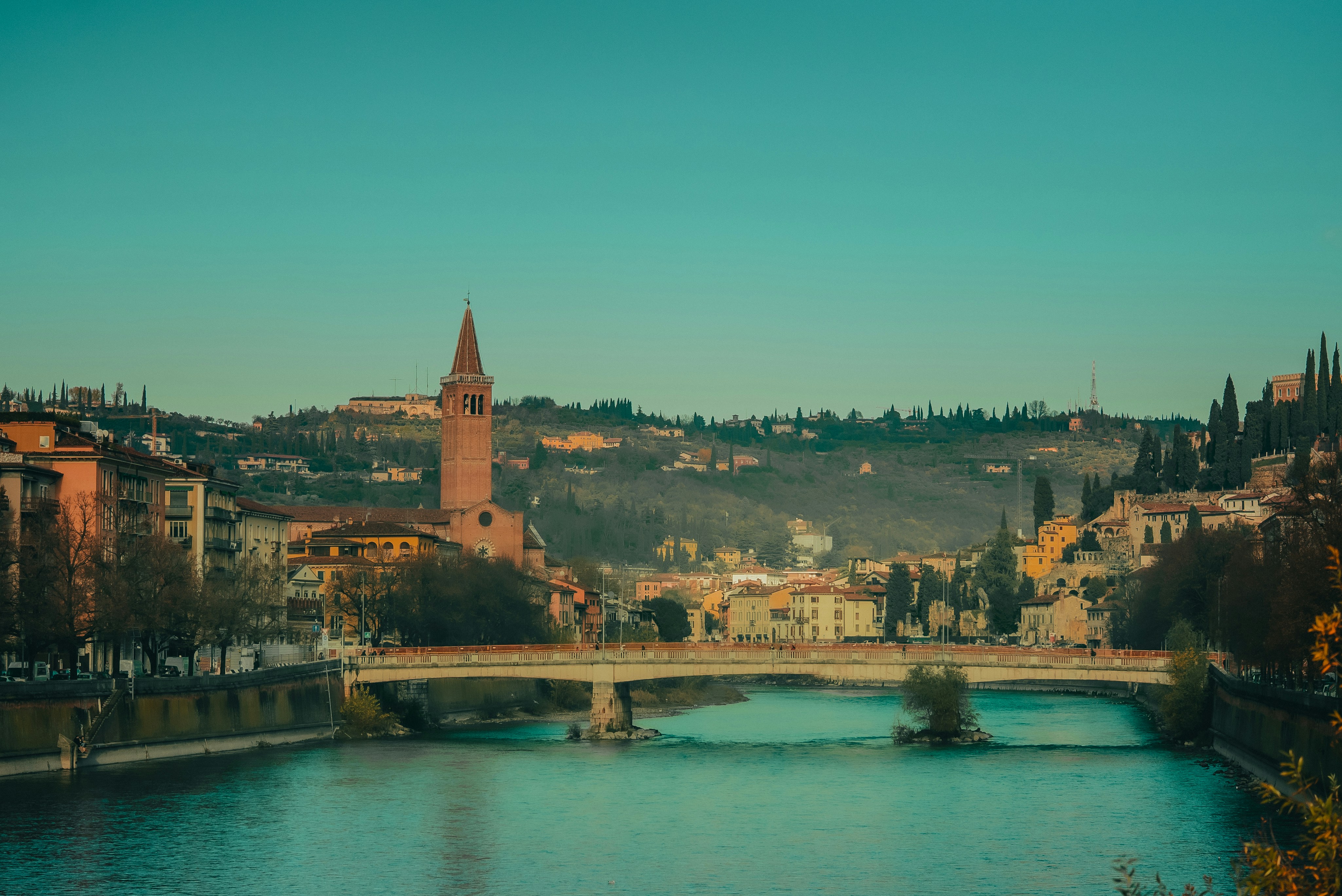 A large body of water with a city in the background photo – Free Italy ...