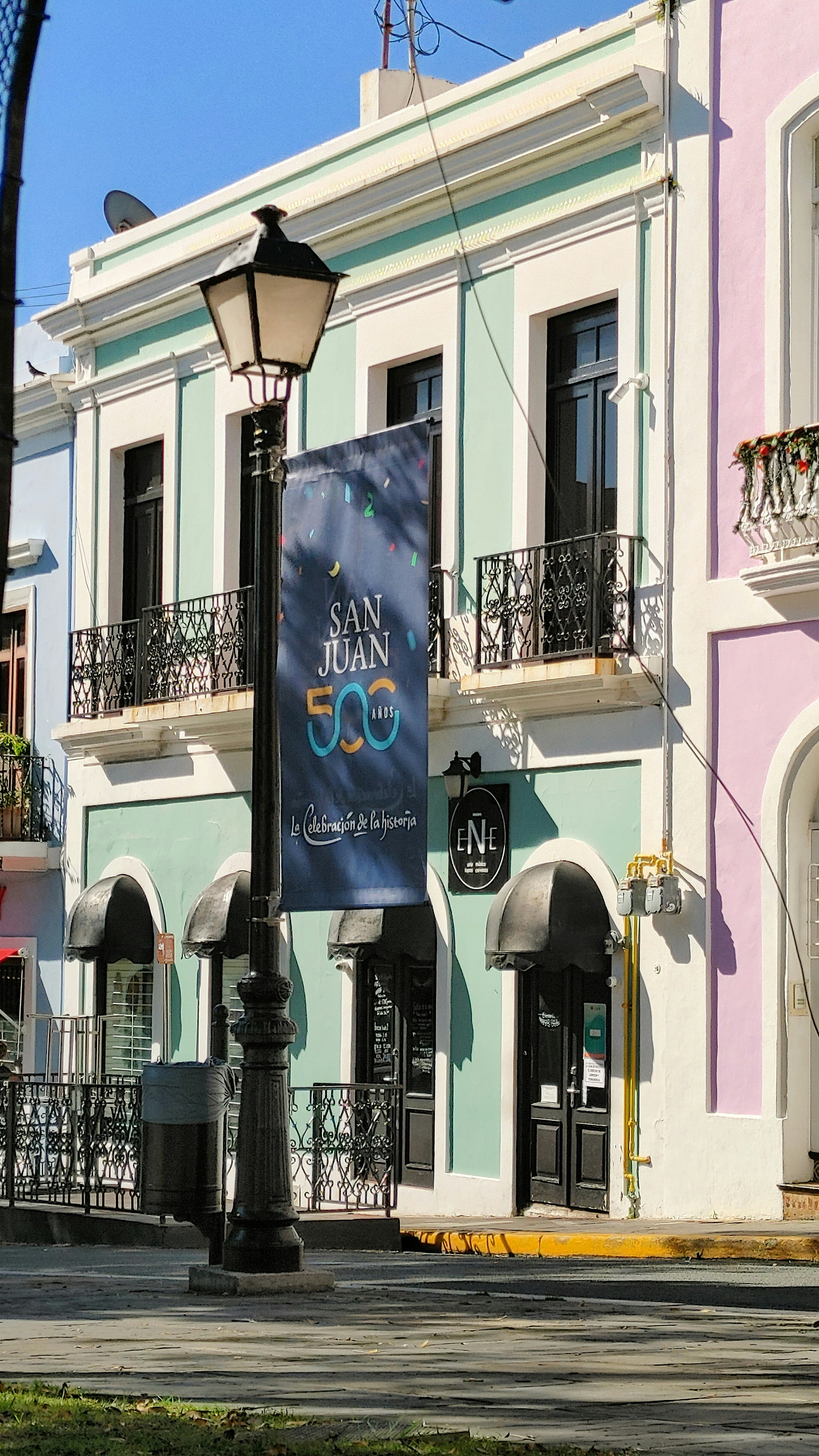 Pastel Facades Under a San Juan Banner