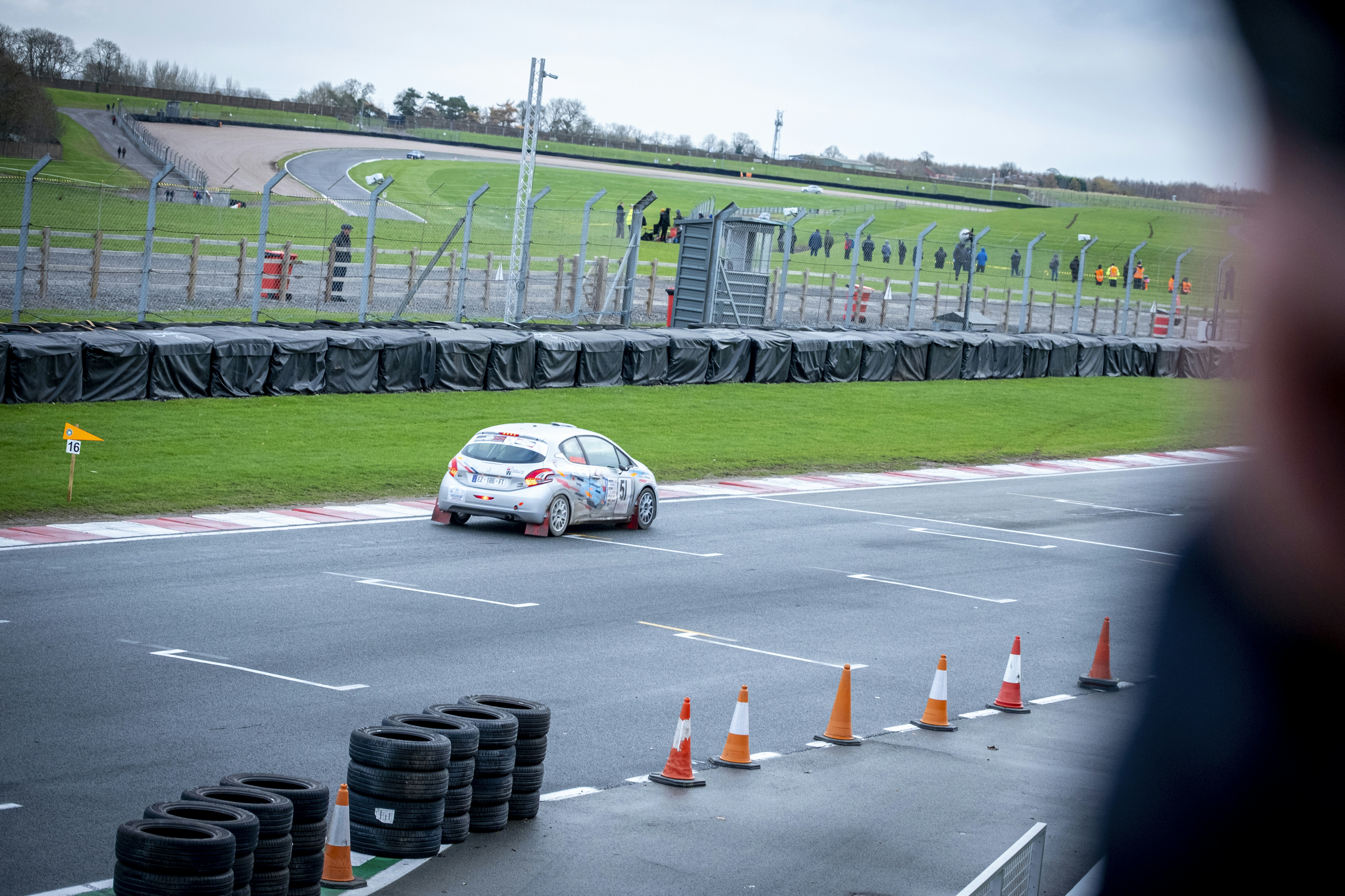 A small car driving down a race track photo – Free Donington park ...