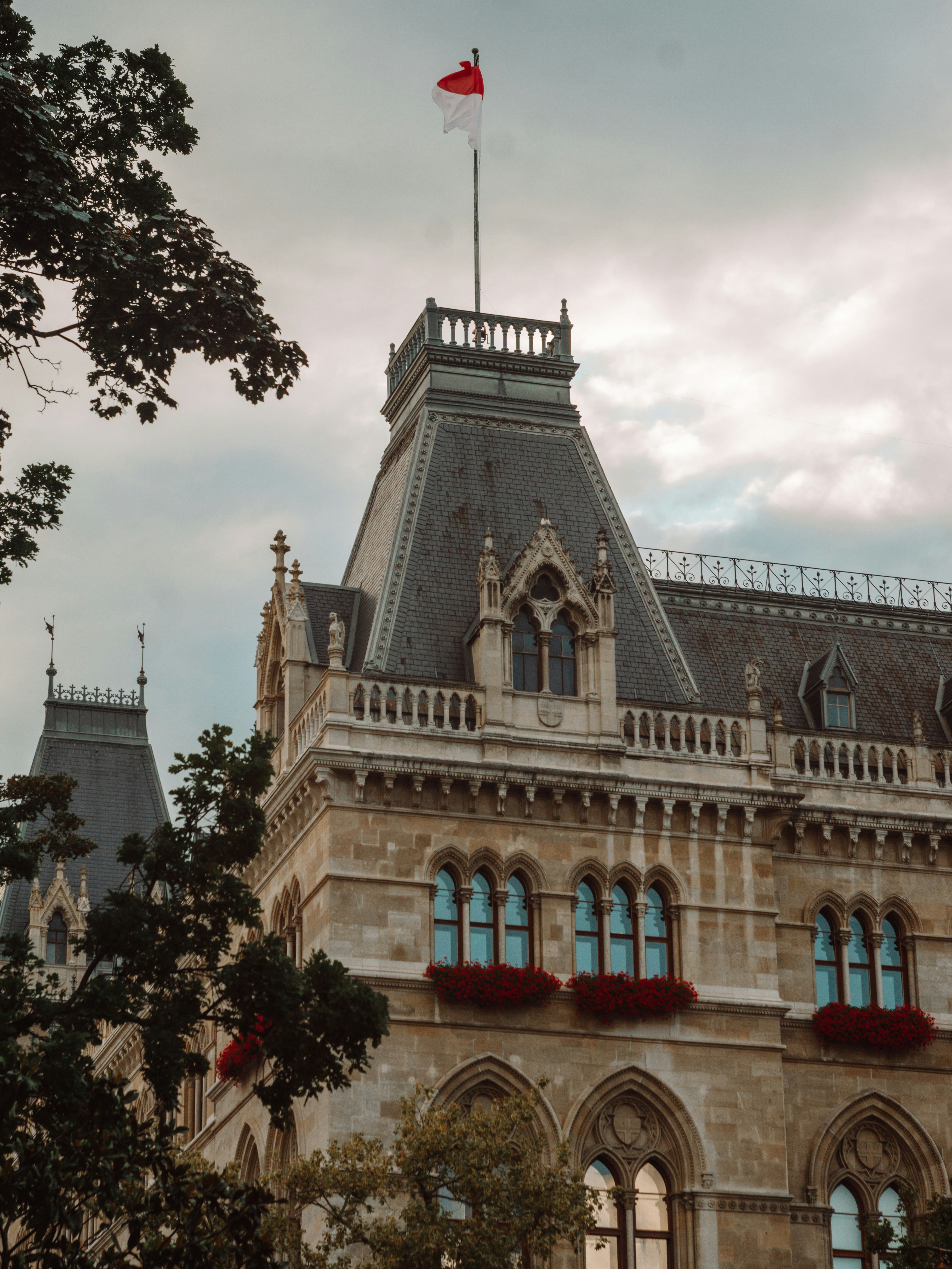 Towering Flag on Neo-Gothic Facade: A Quiet Monument Against the Sky