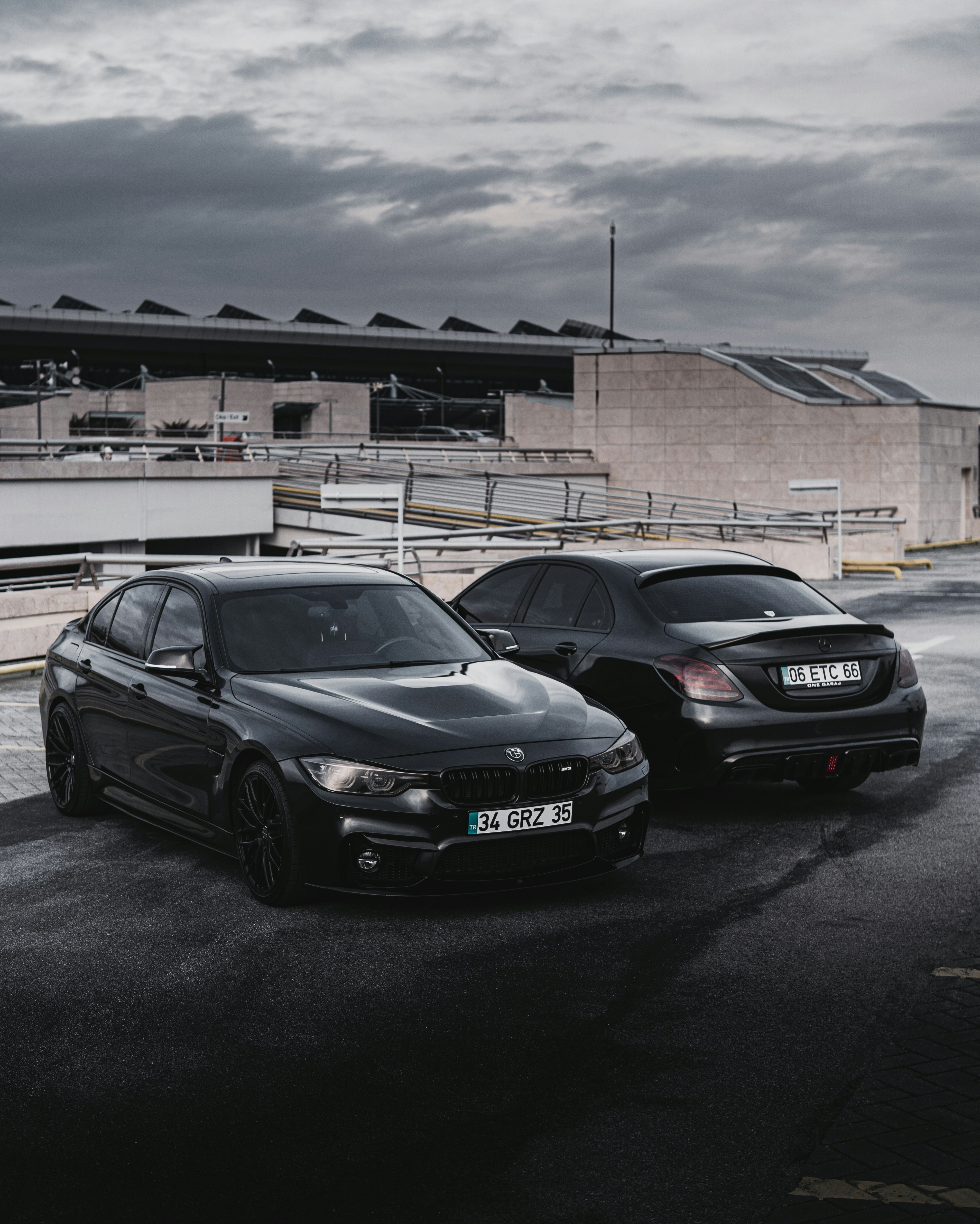 Two cars parked next to each other in a parking lot photo – Free ...