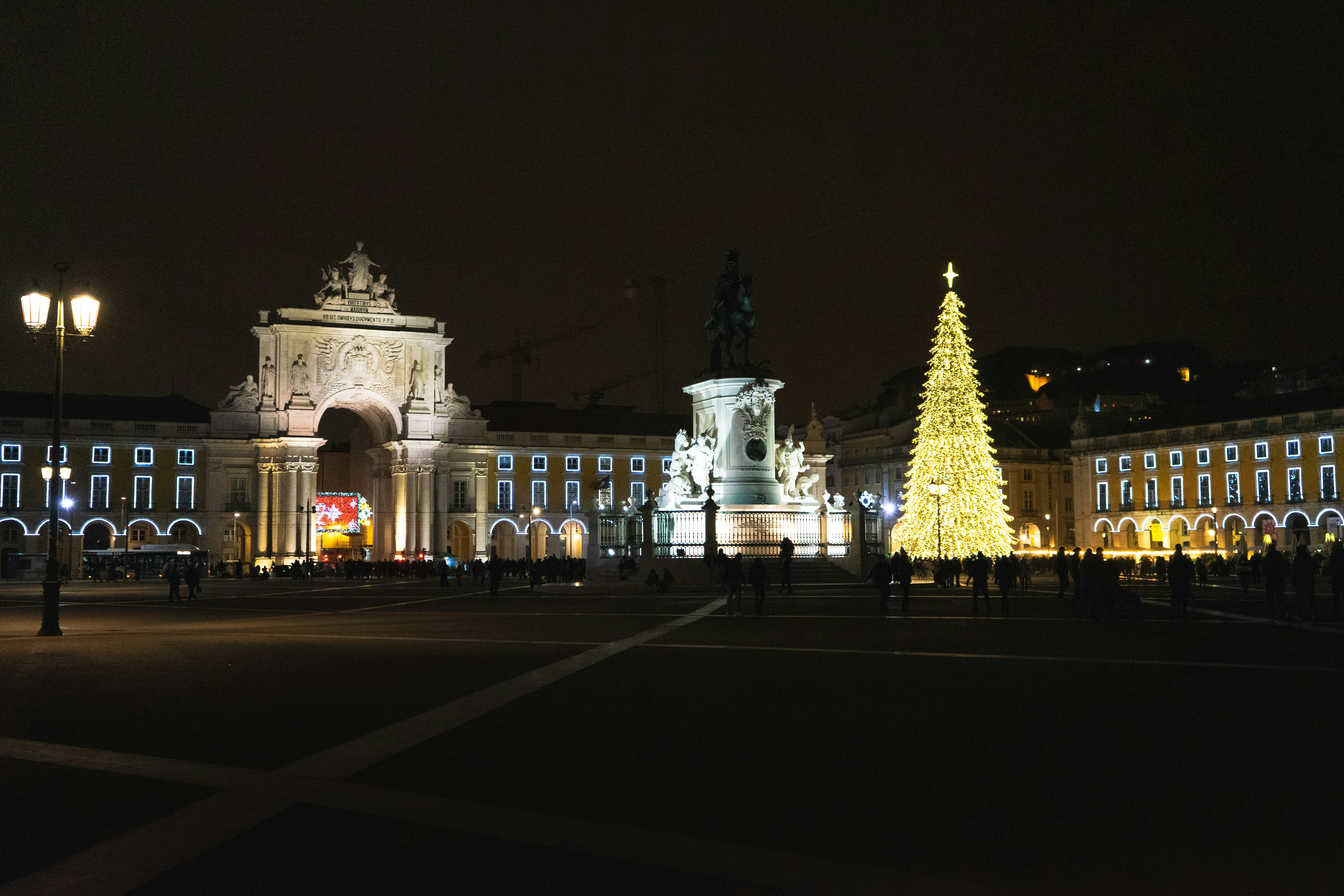 Arcade of Light: Christmas Tree Glow in a Nighttime City Square