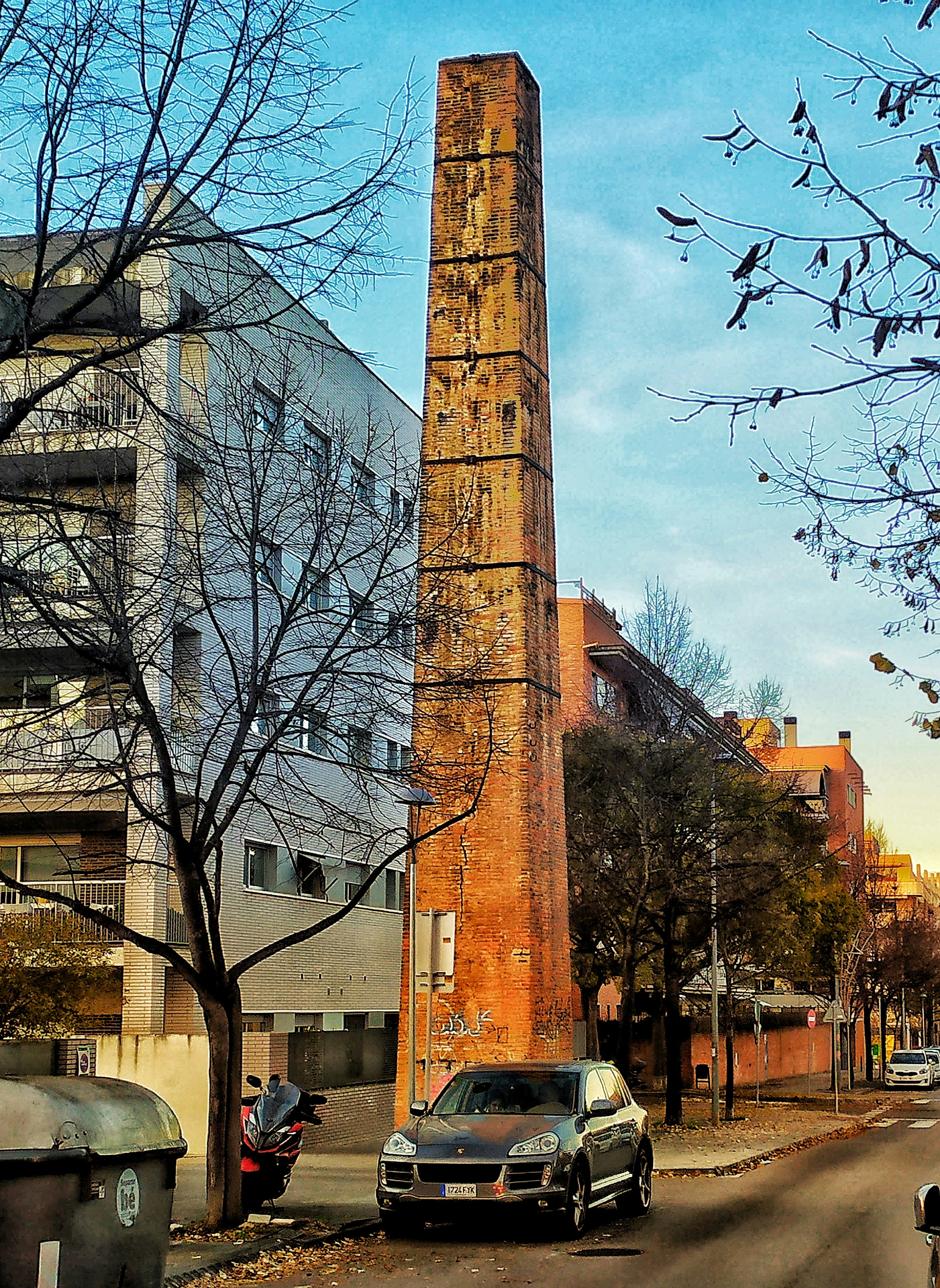Brick Chimney Rising Over a Quiet Urban Street