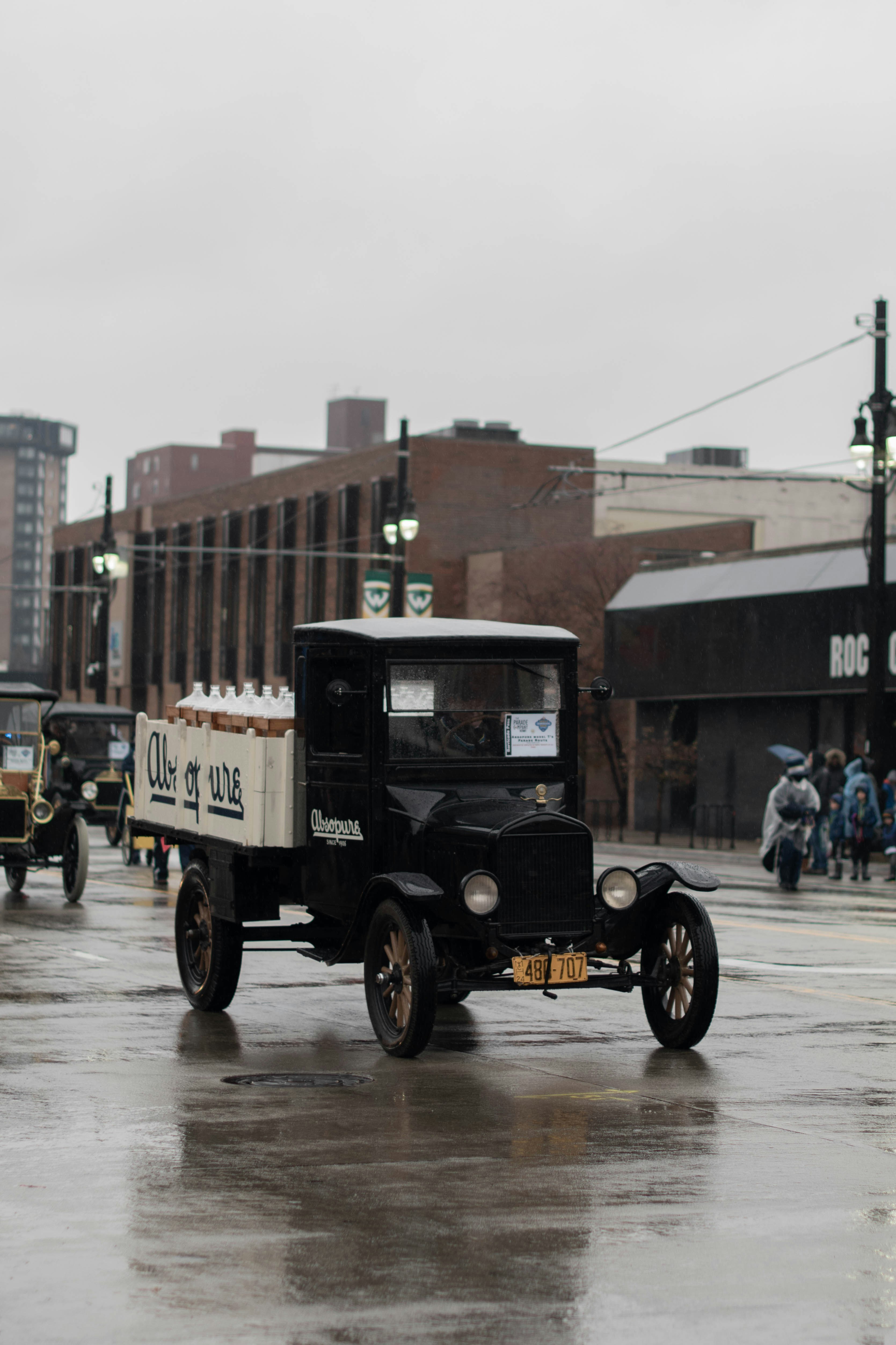 Rain-Washed Relic: A Vintage Truck Rumbles Through a Moody City Street