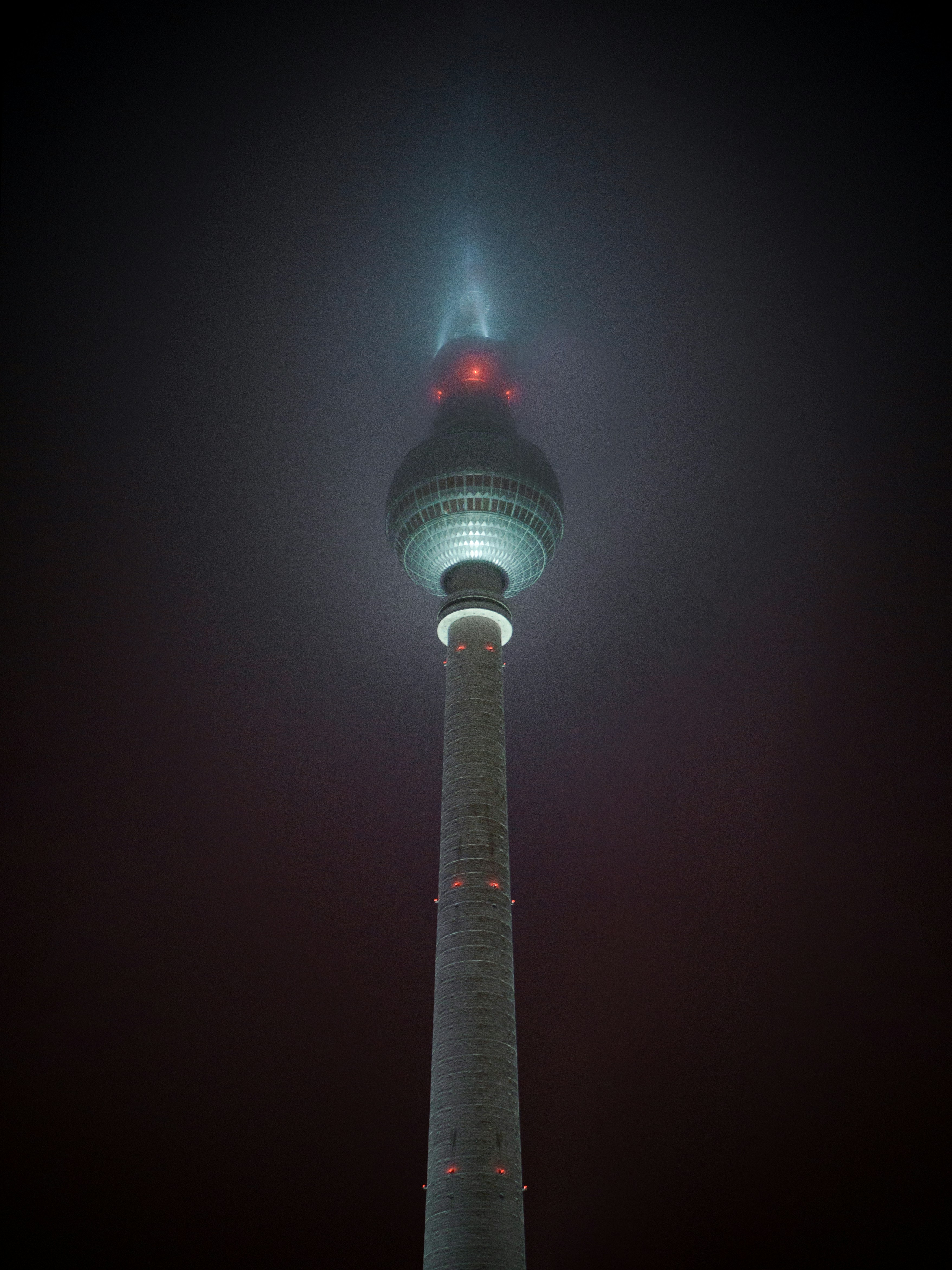 a tall tower with a red light on top of it