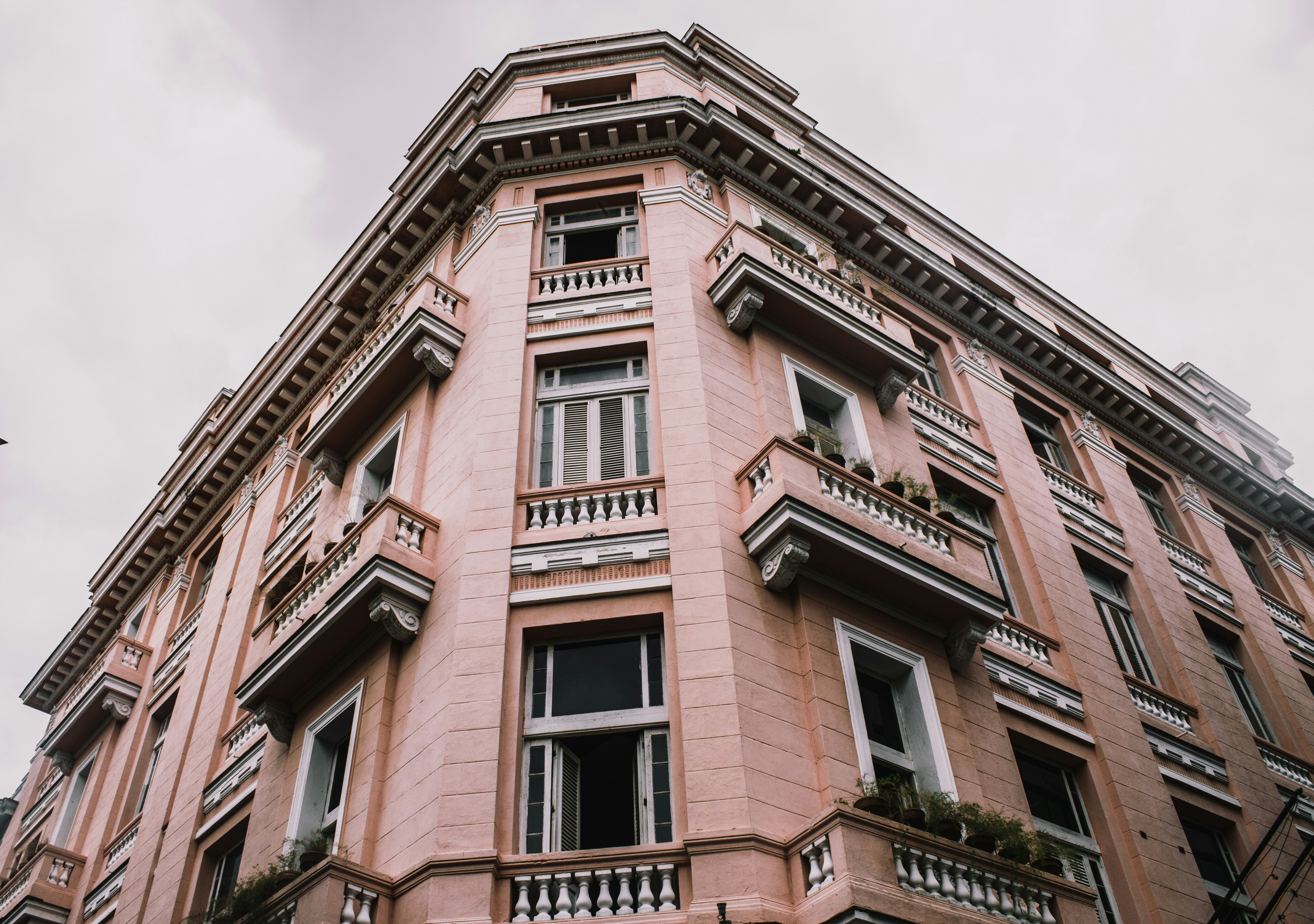 A tall pink building with balconies and windows photo – Free Cuba Image ...