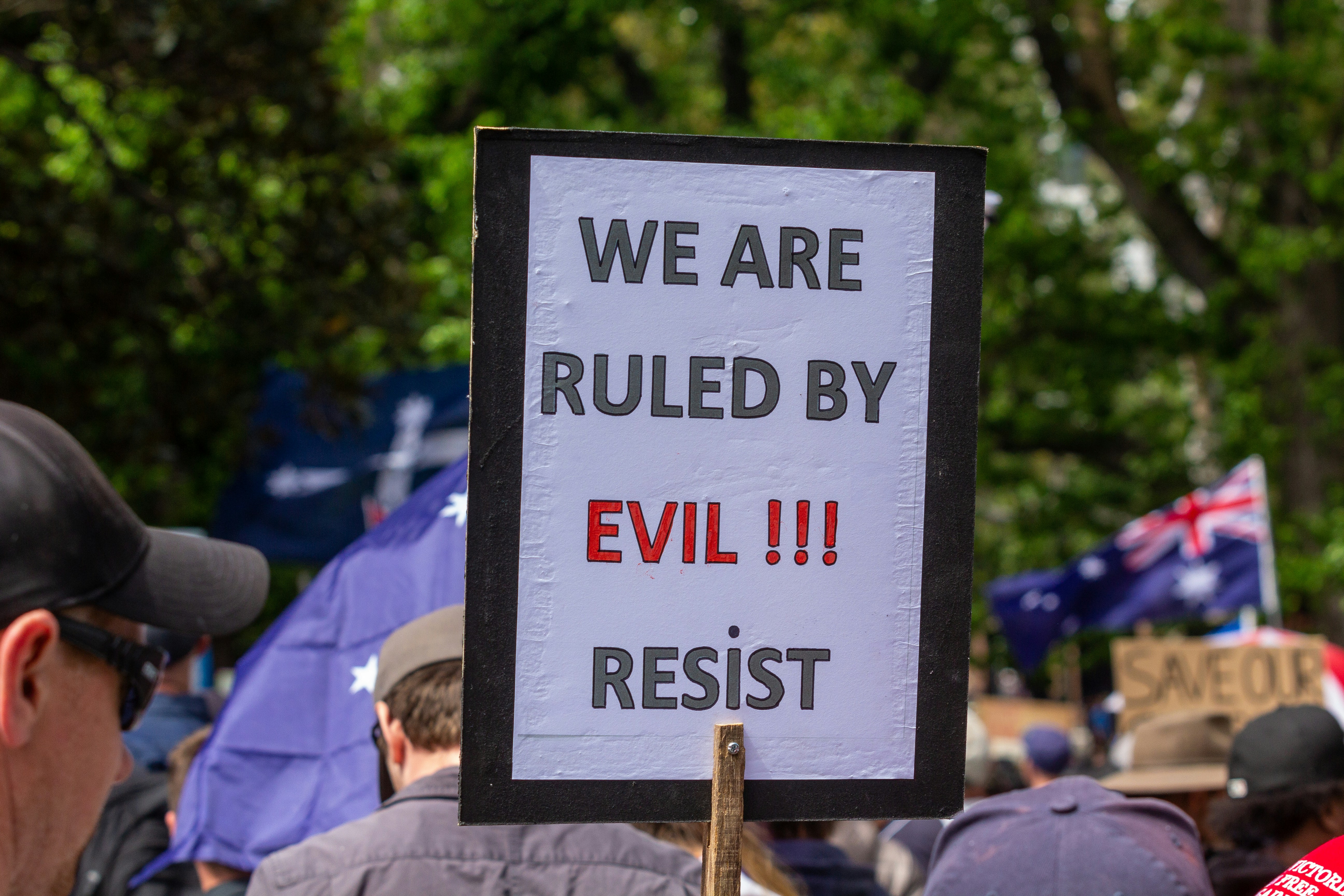 A protest sign in front of a crowd of people photo – Free Crowd Image ...