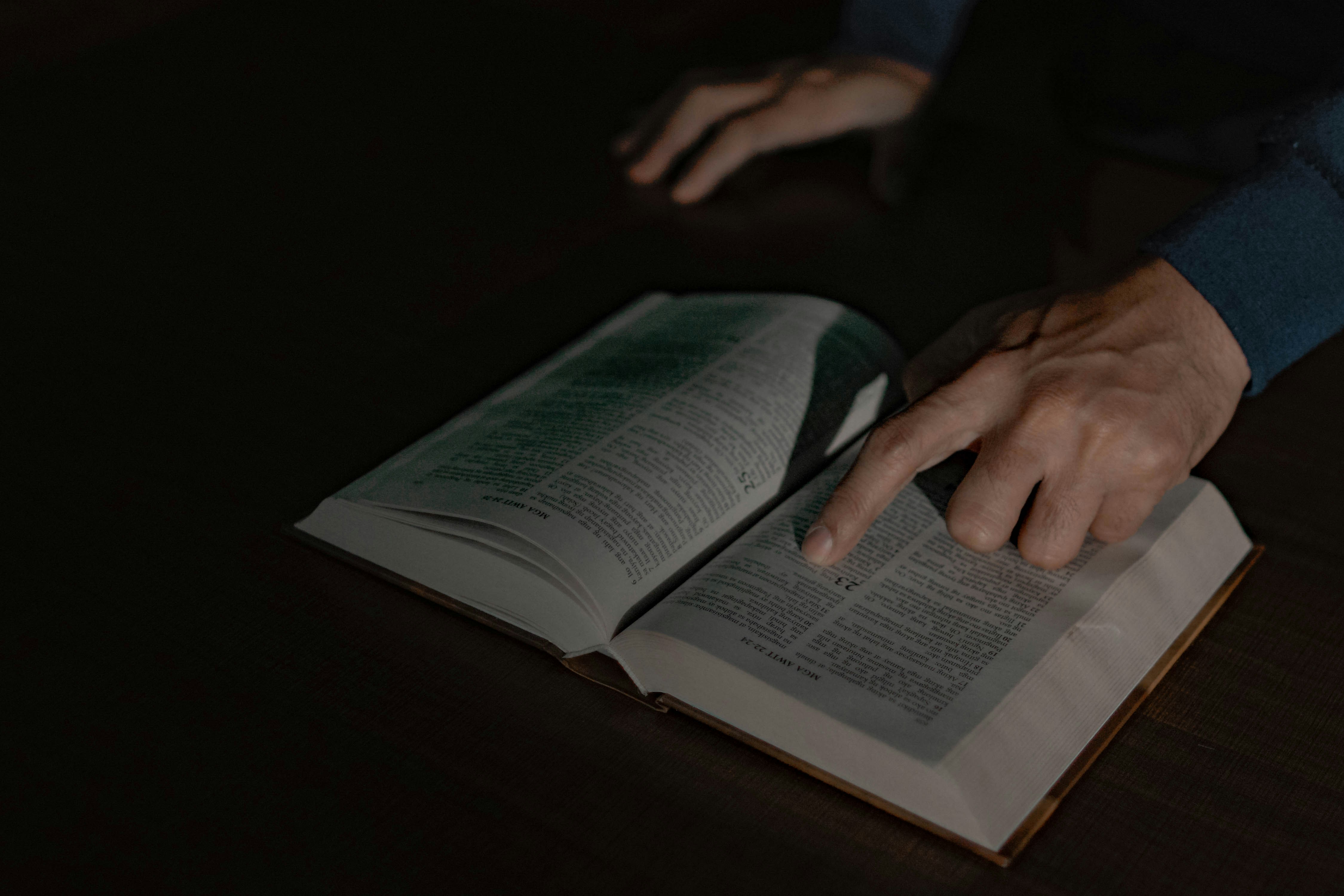 A person touching a book with their hand photo – Free Bible study Image ...