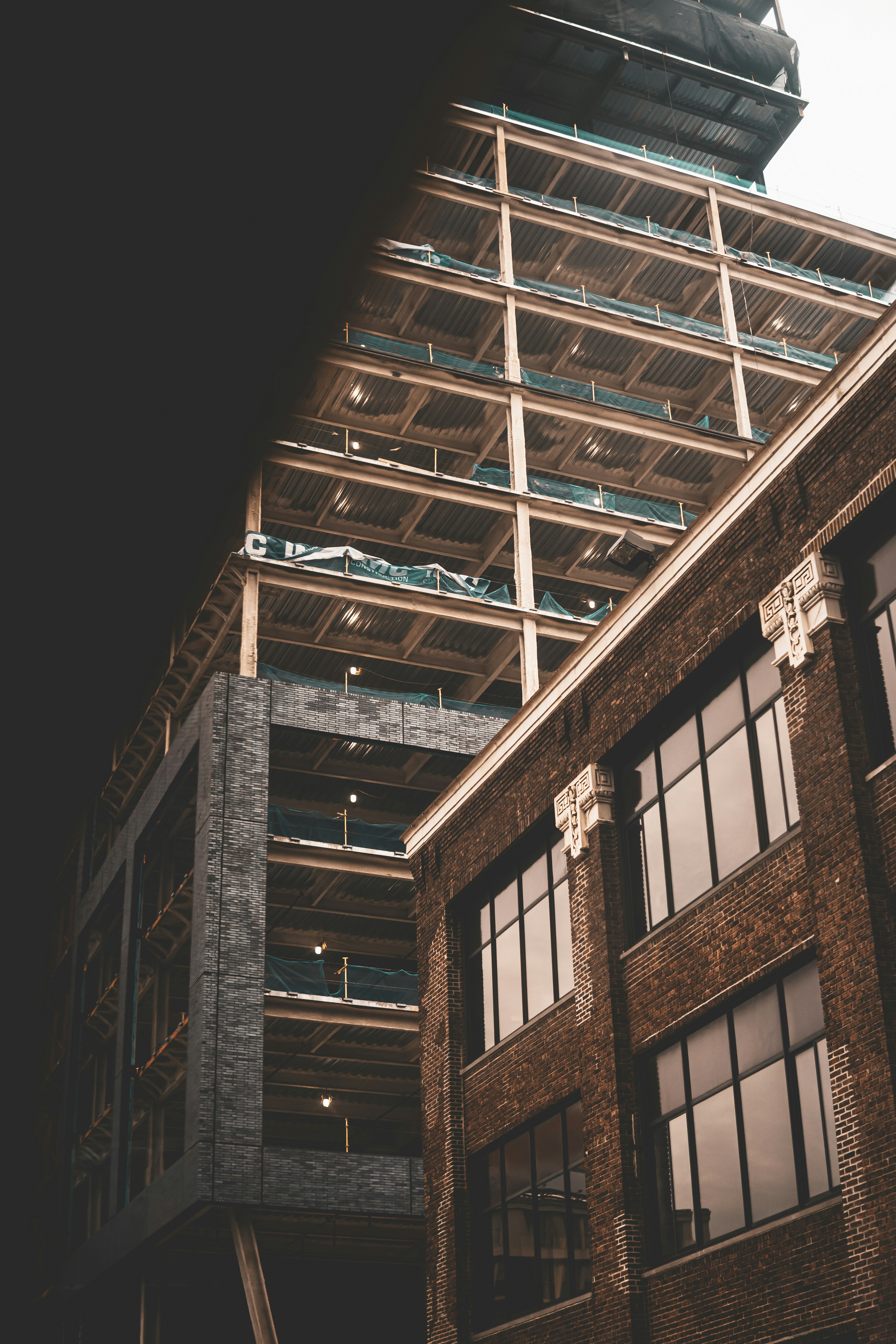 A tall building with lots of windows under construction photo – Free Pa ...