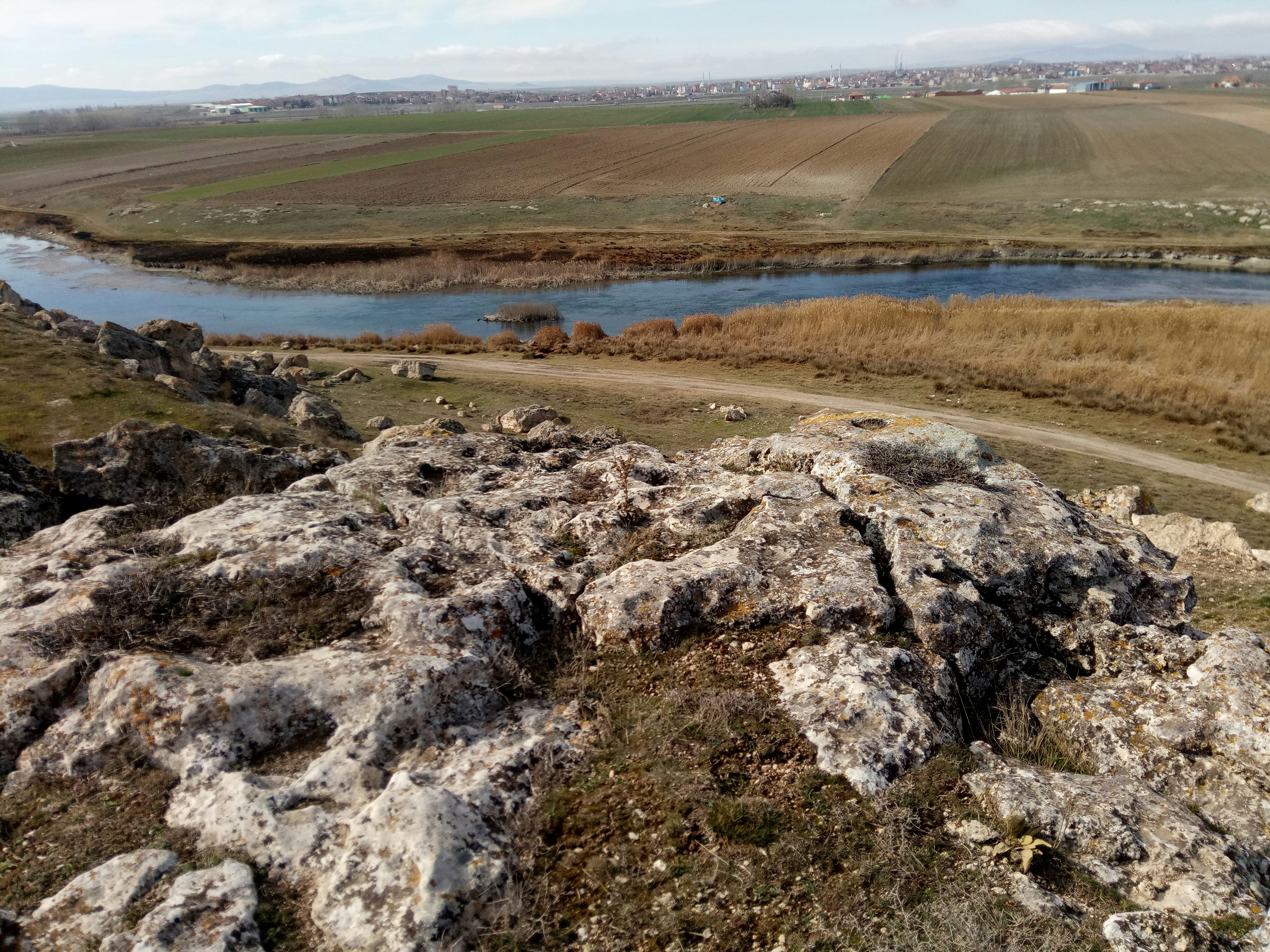 Rugged Outcrop Overlooking Serene Waterway