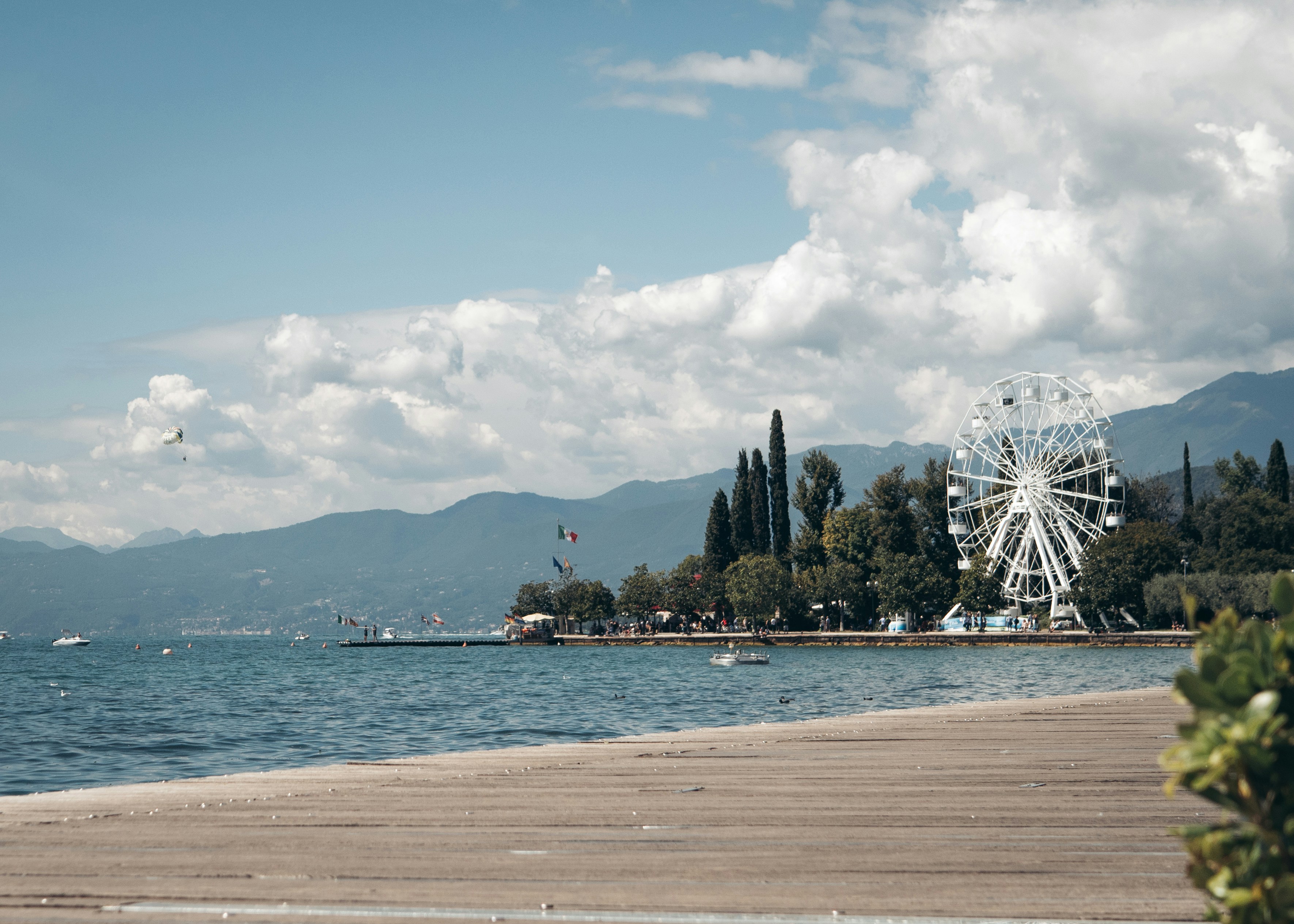 Ferris Wheel Over the Lakeside Promenade: Quiet Day, Distant Mountains