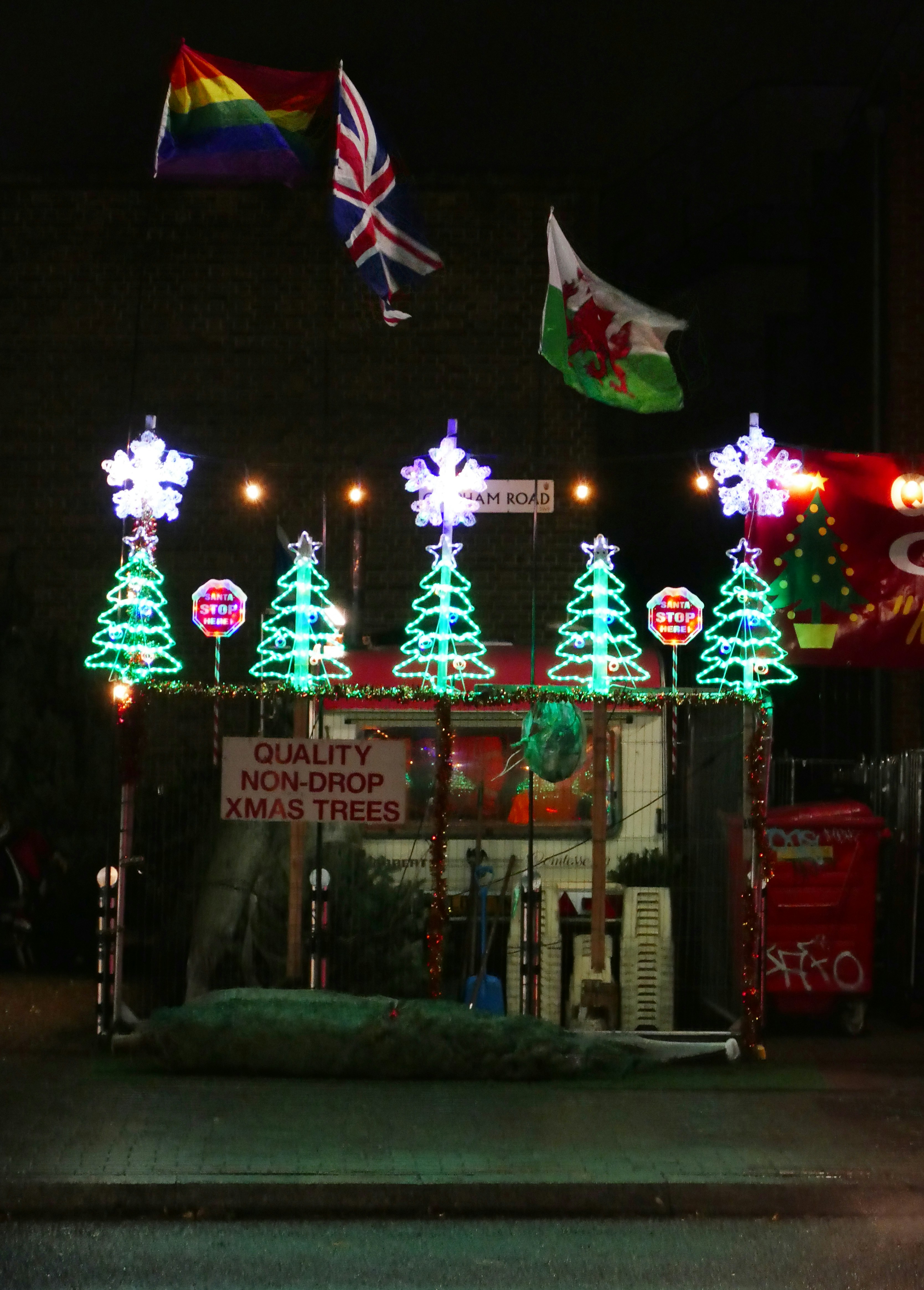 Neon Christmas Trees Light Up a Night Market Stall