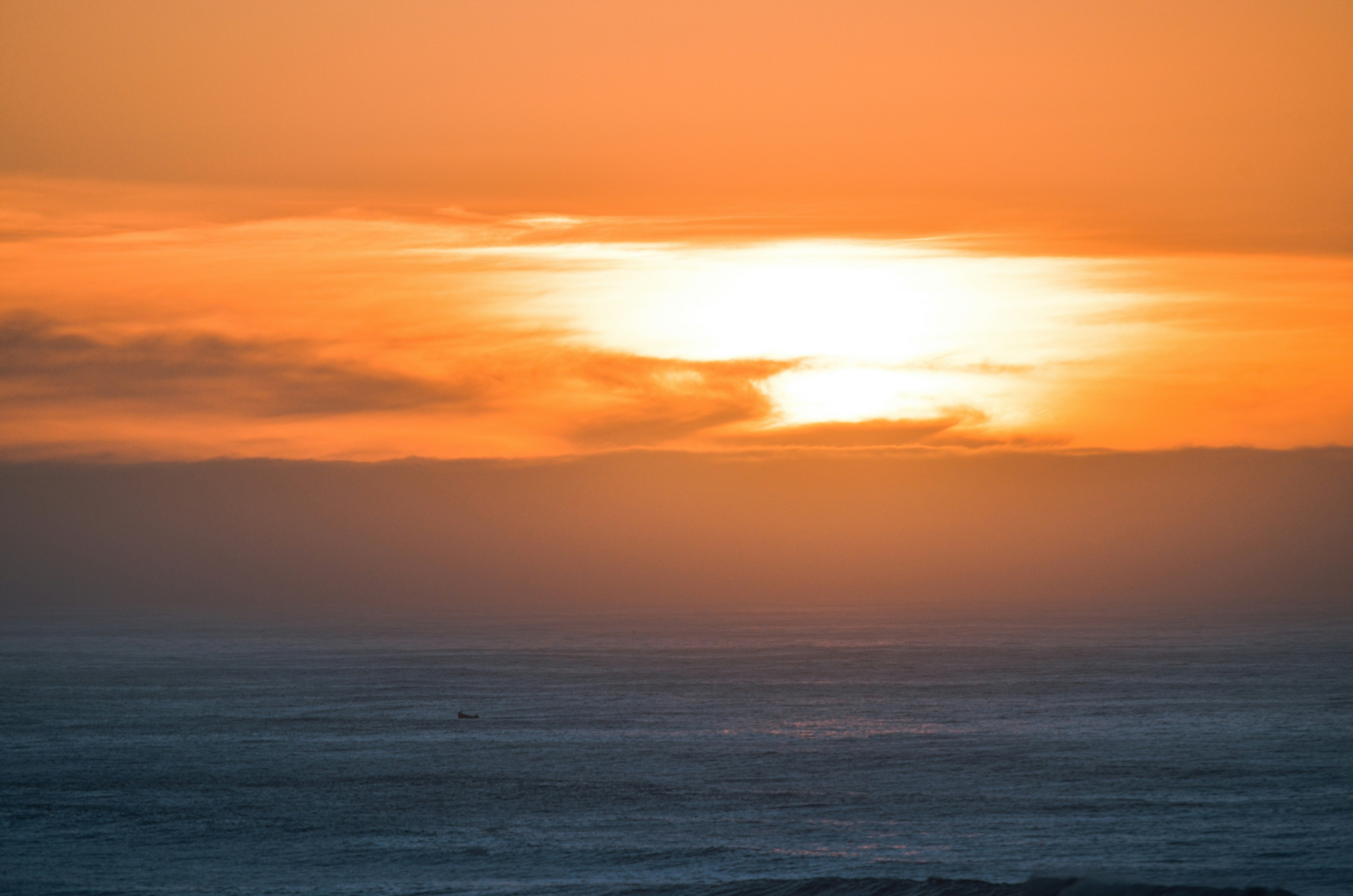 beautiful view of sunset | the sun is setting over the ocean on a cloudy day