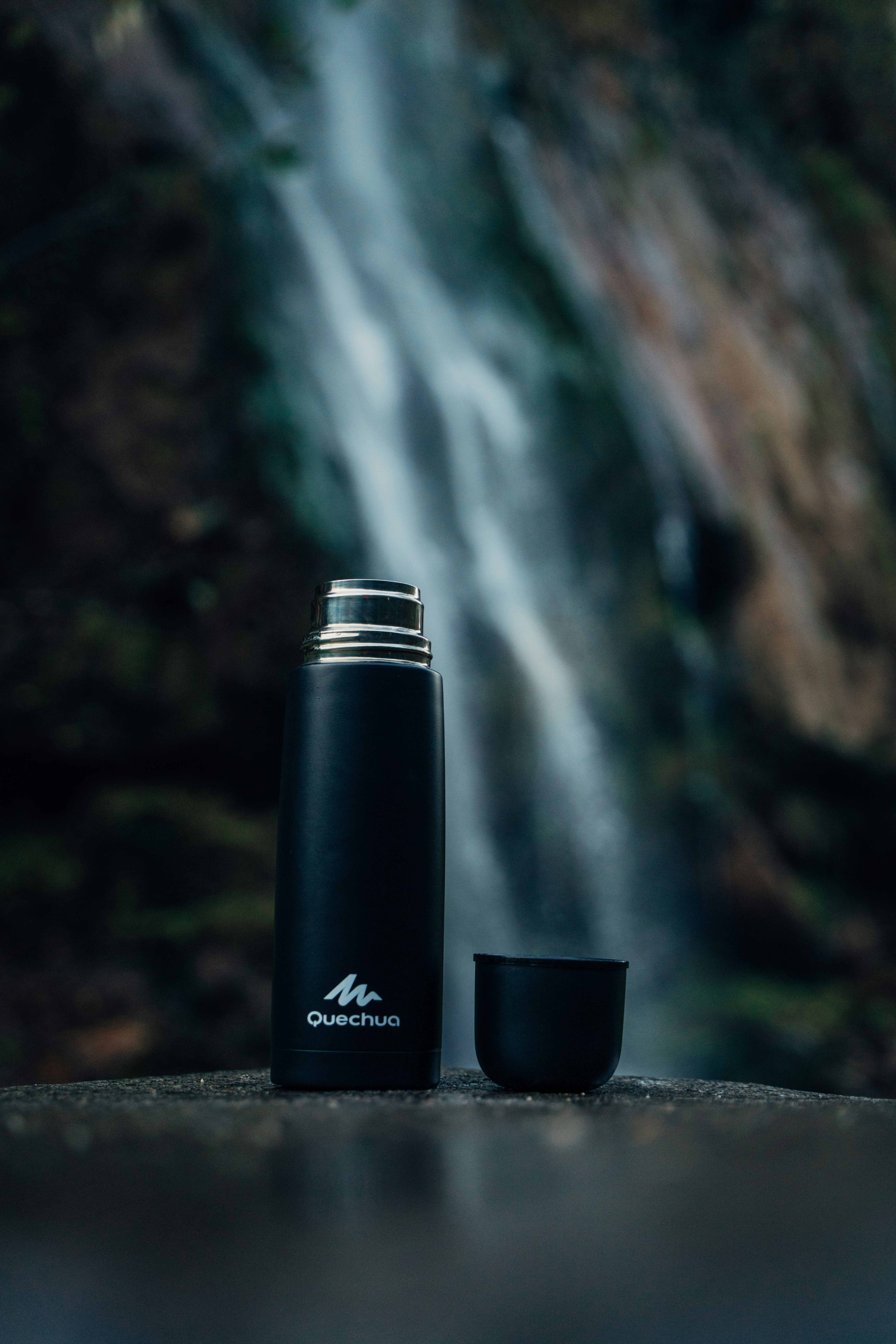 Hydration in Focus: A Quechua Bottle by a Velvet Waterfall