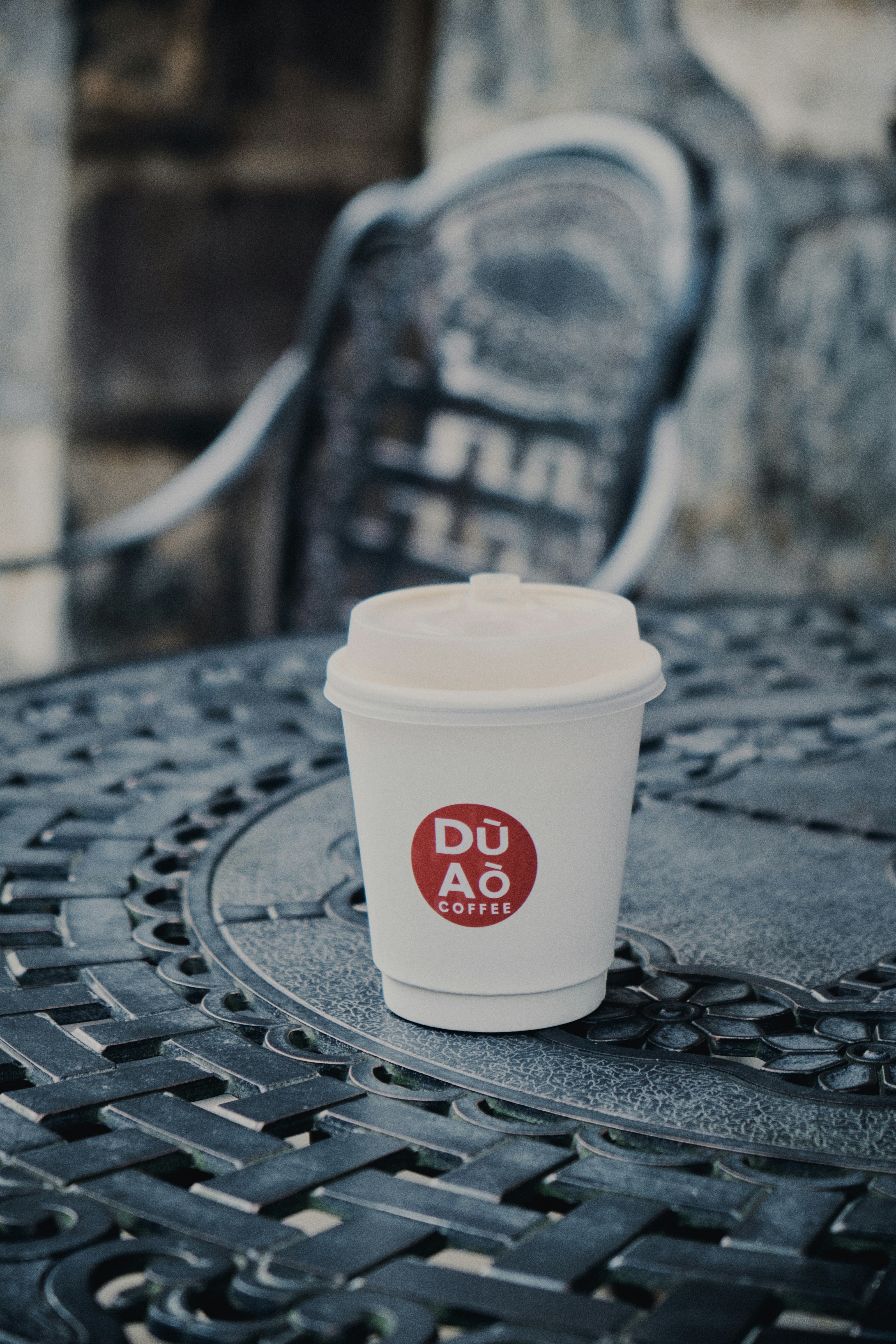 Solo Takeaway Cup Anchored on a Textured Patio Table