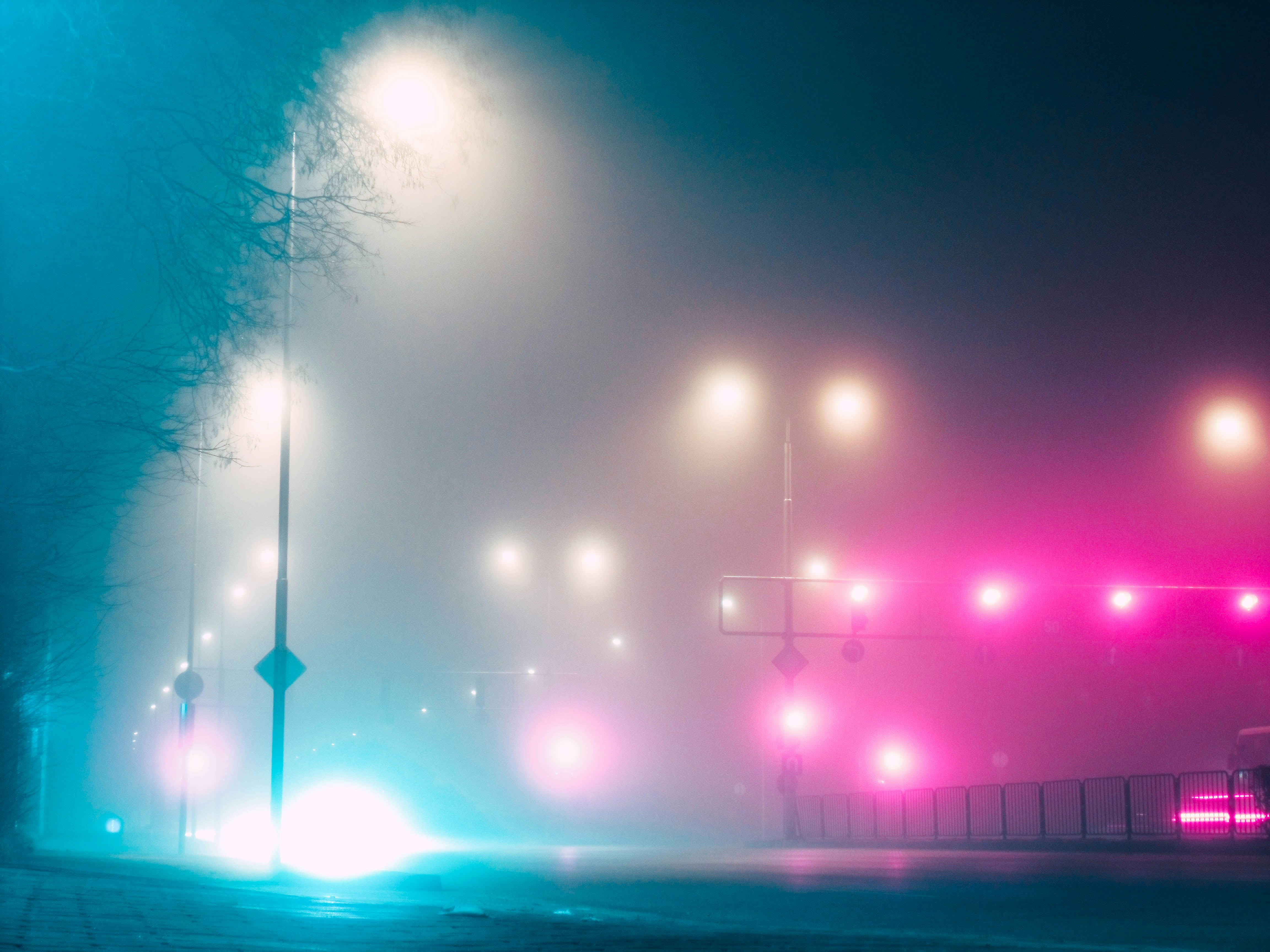 A foggy night with street lights and street signs photo – Free Winter ...