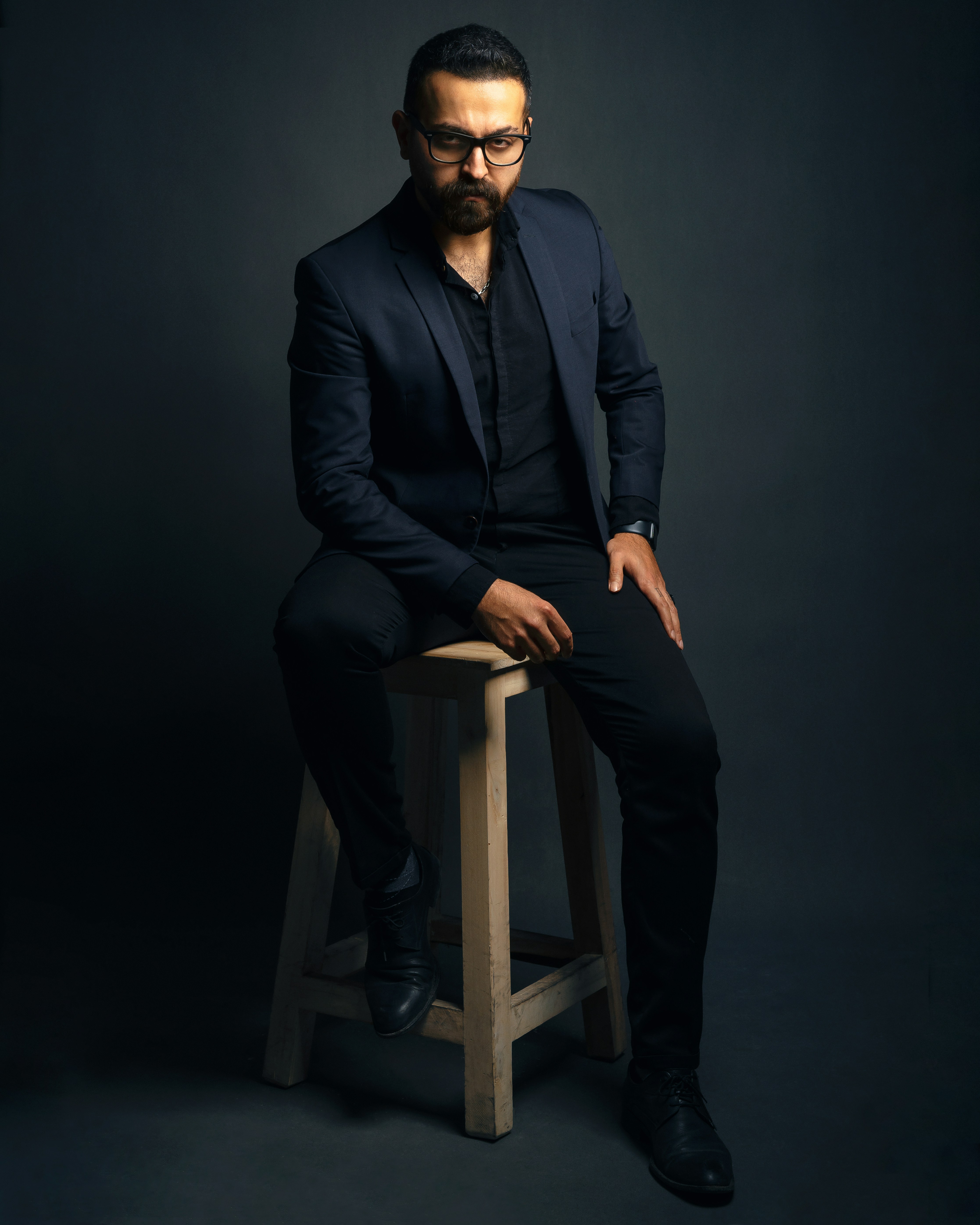 Noir Quietude: A Suit, a Stool, and a Moment of Resolve