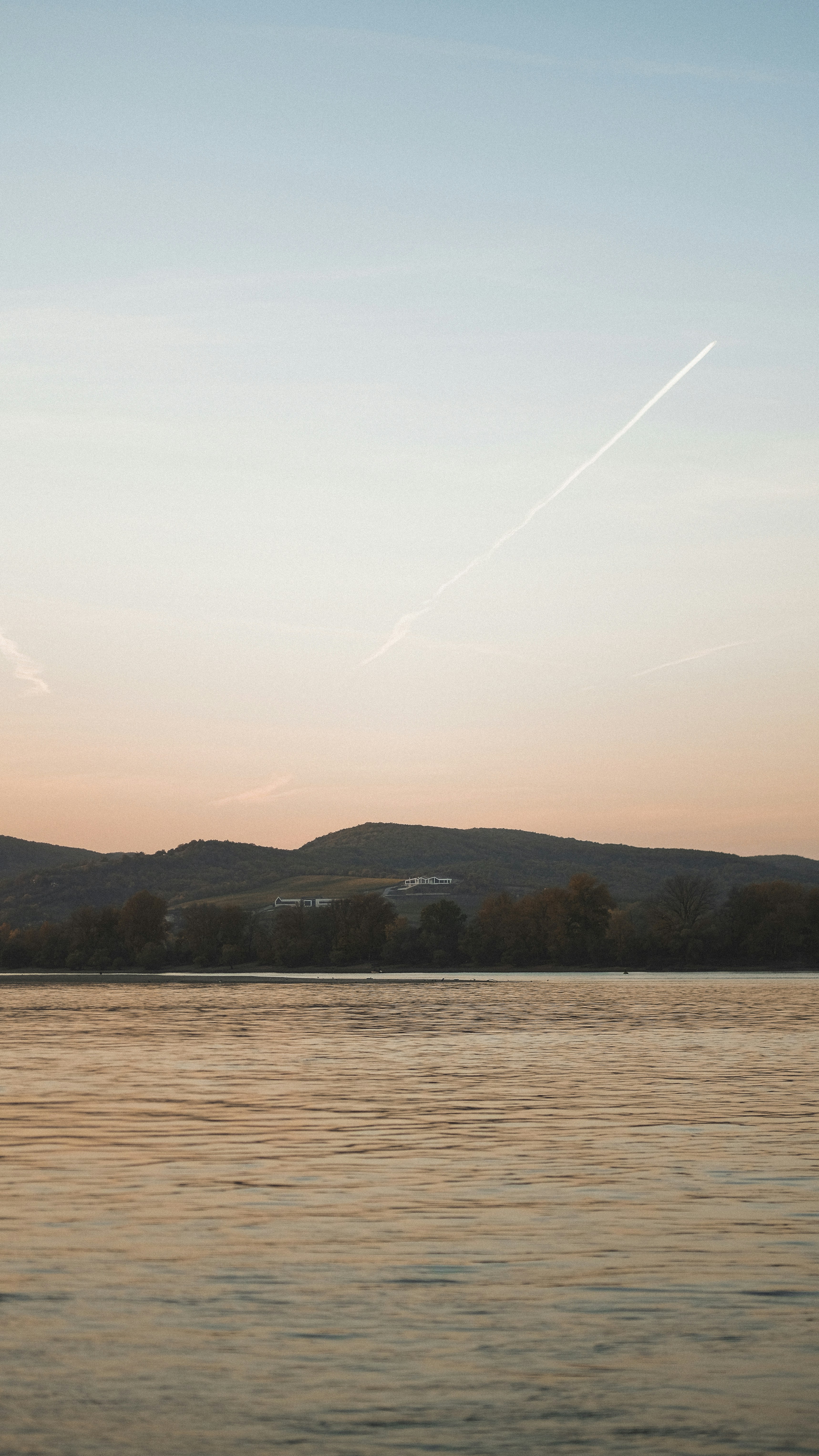 A plane flying over a body of water photo – Free Nature Image on Unsplash