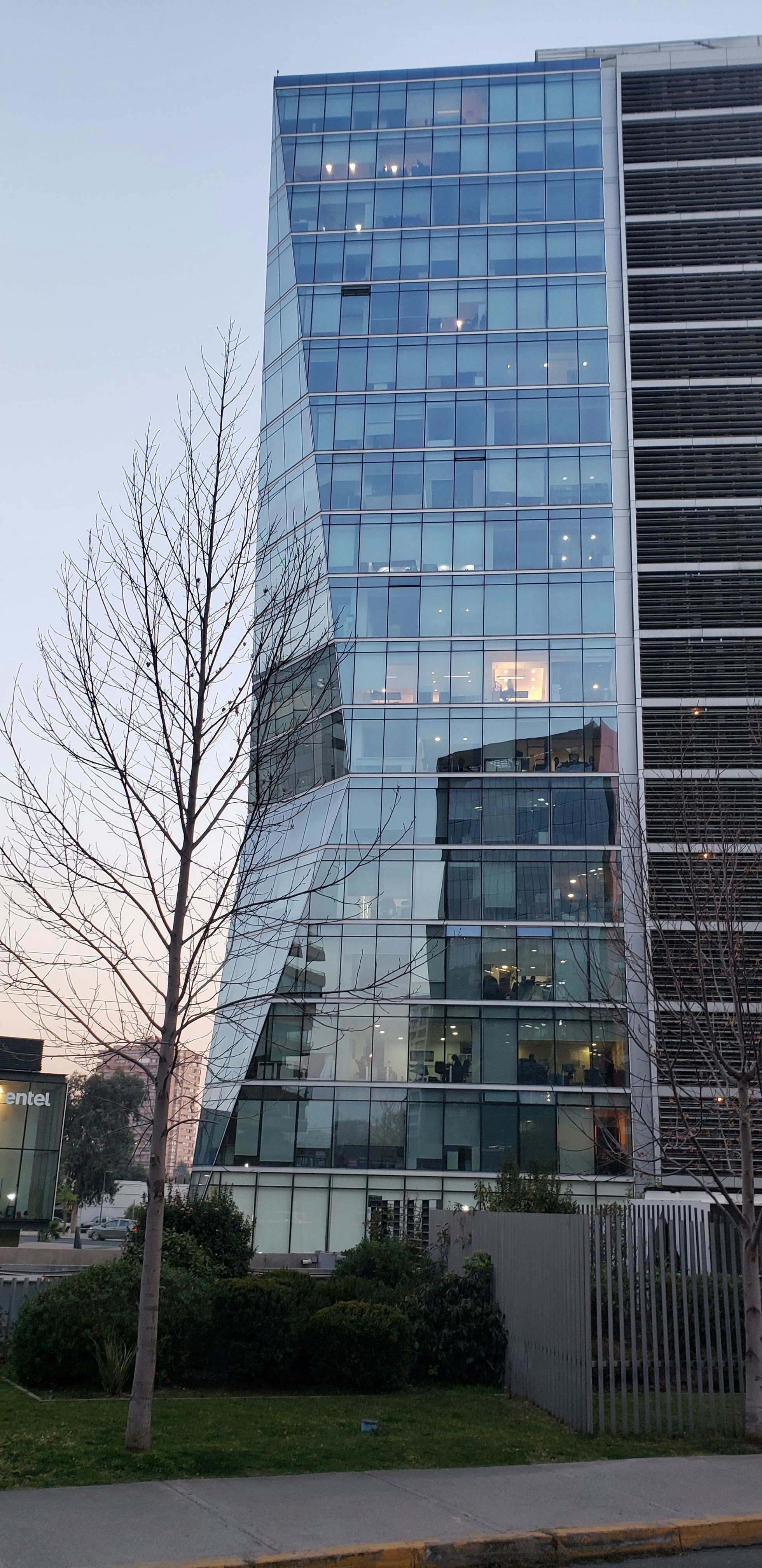 Dusk Reflections on a Slanted Glass Tower