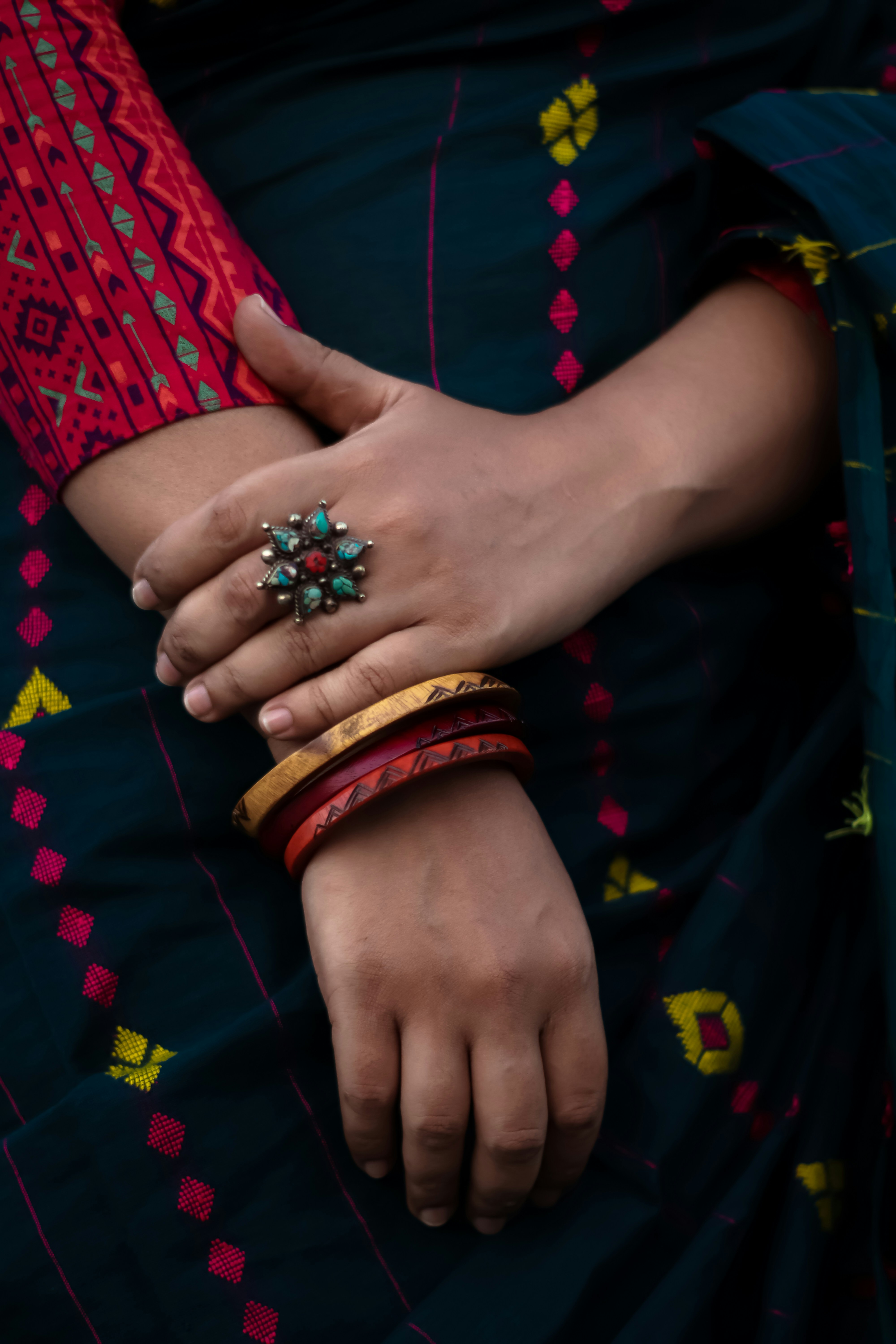 a close up of a person's hands wearing bracelets
