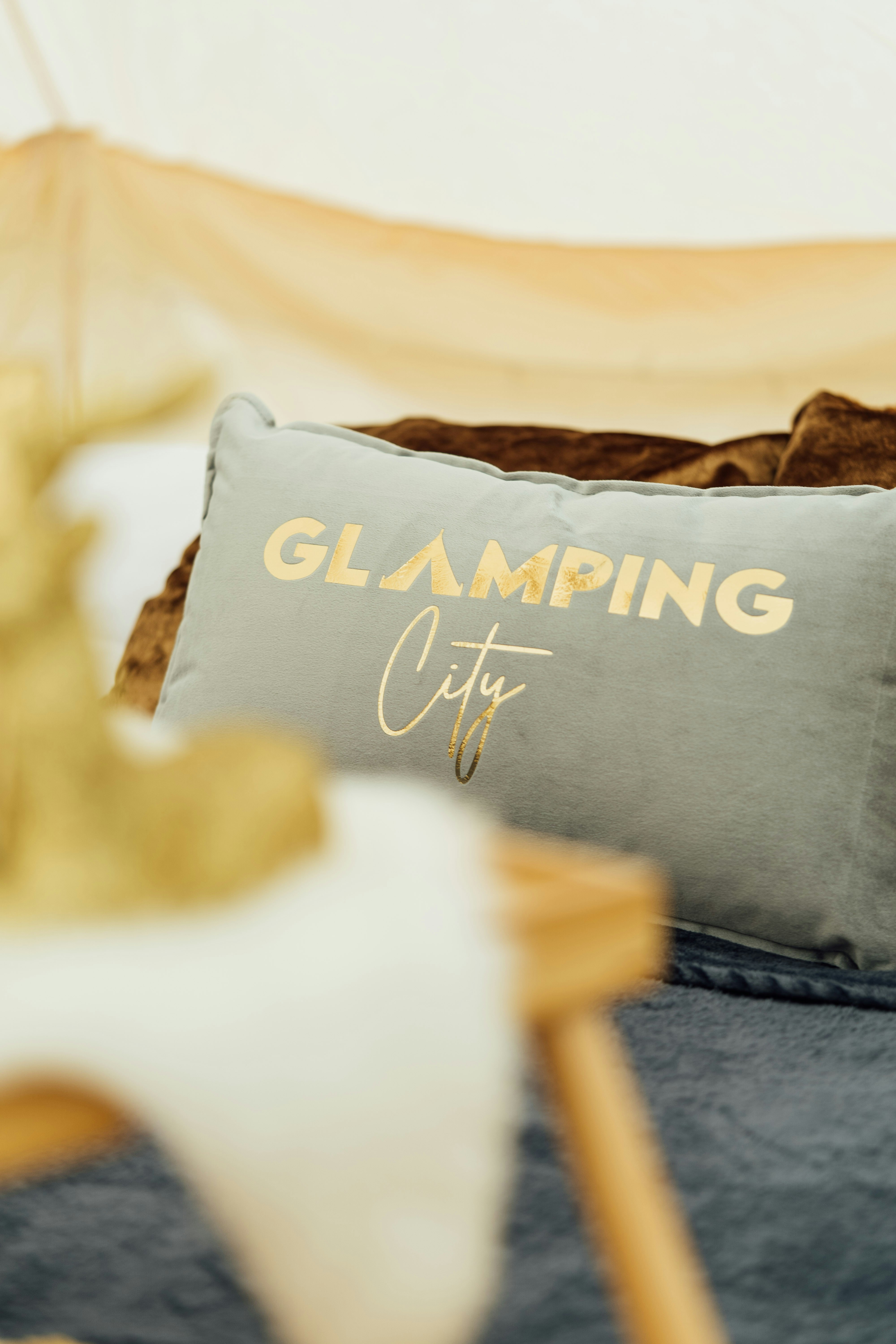 Glamping City Pillow: a sunlit lounge vignette on a plush indoor setup