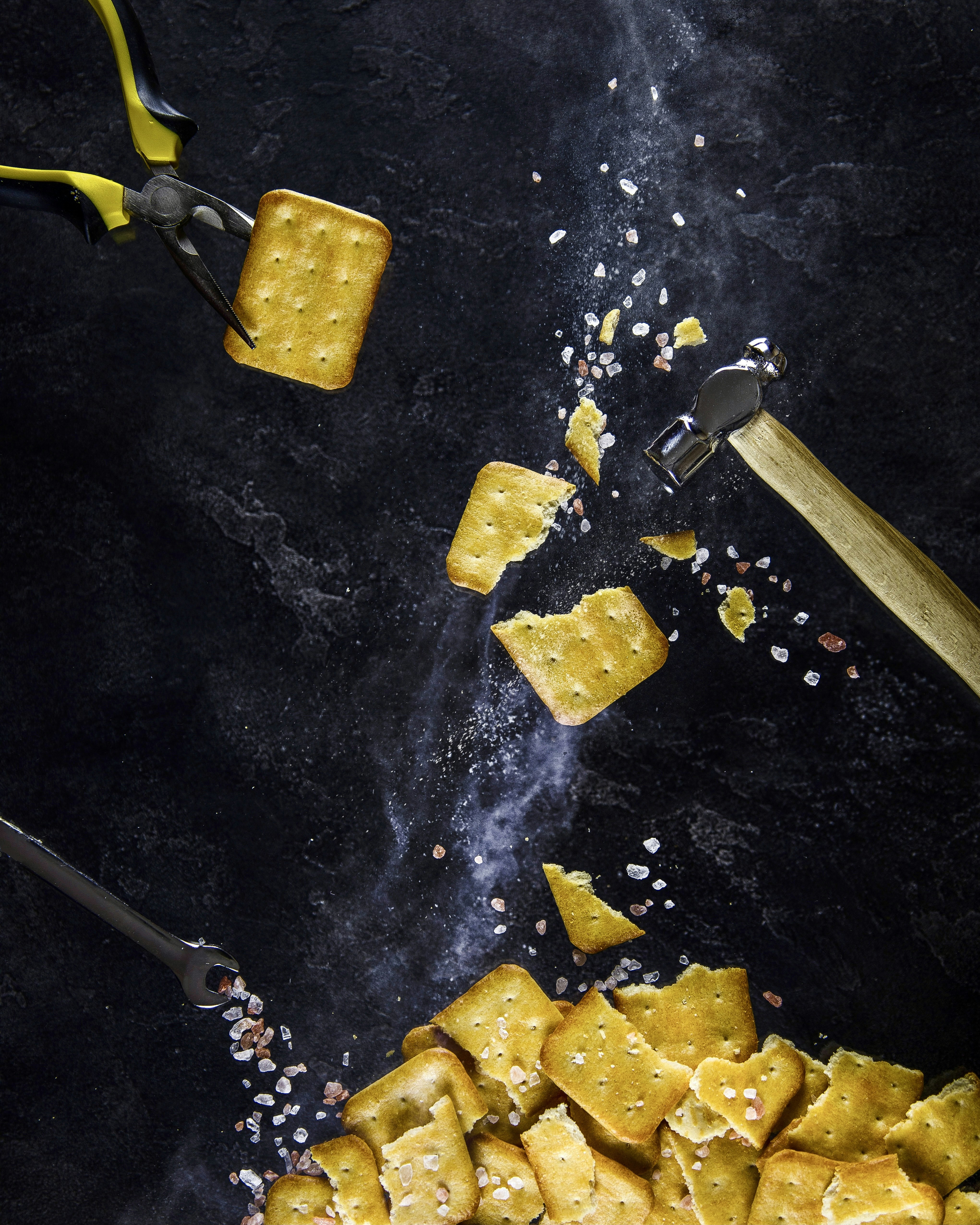 Crackers in a midair tumble: a bite of chaos over a dark surface