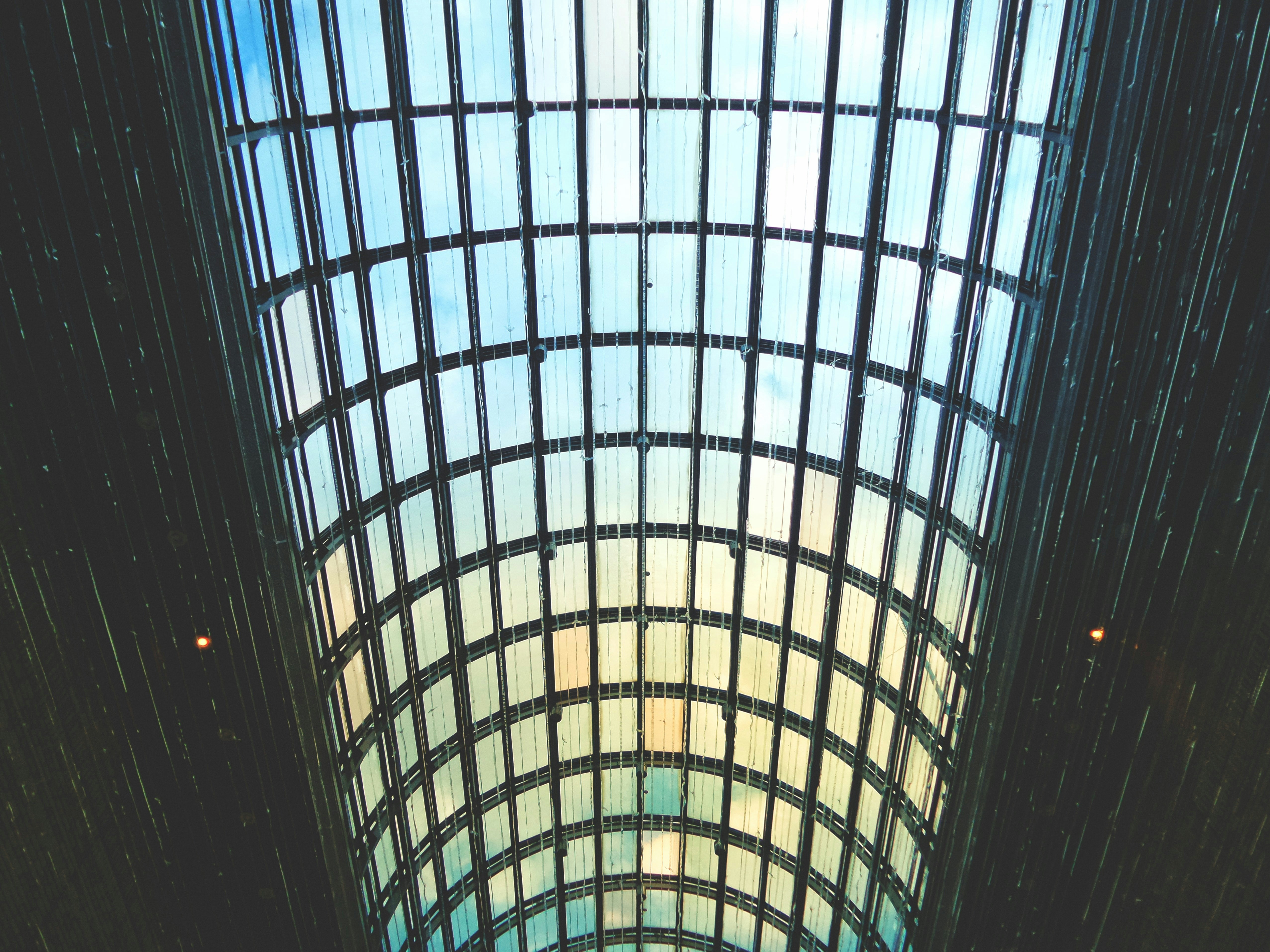 A view of the ceiling of a building through a glass window photo – Free ...