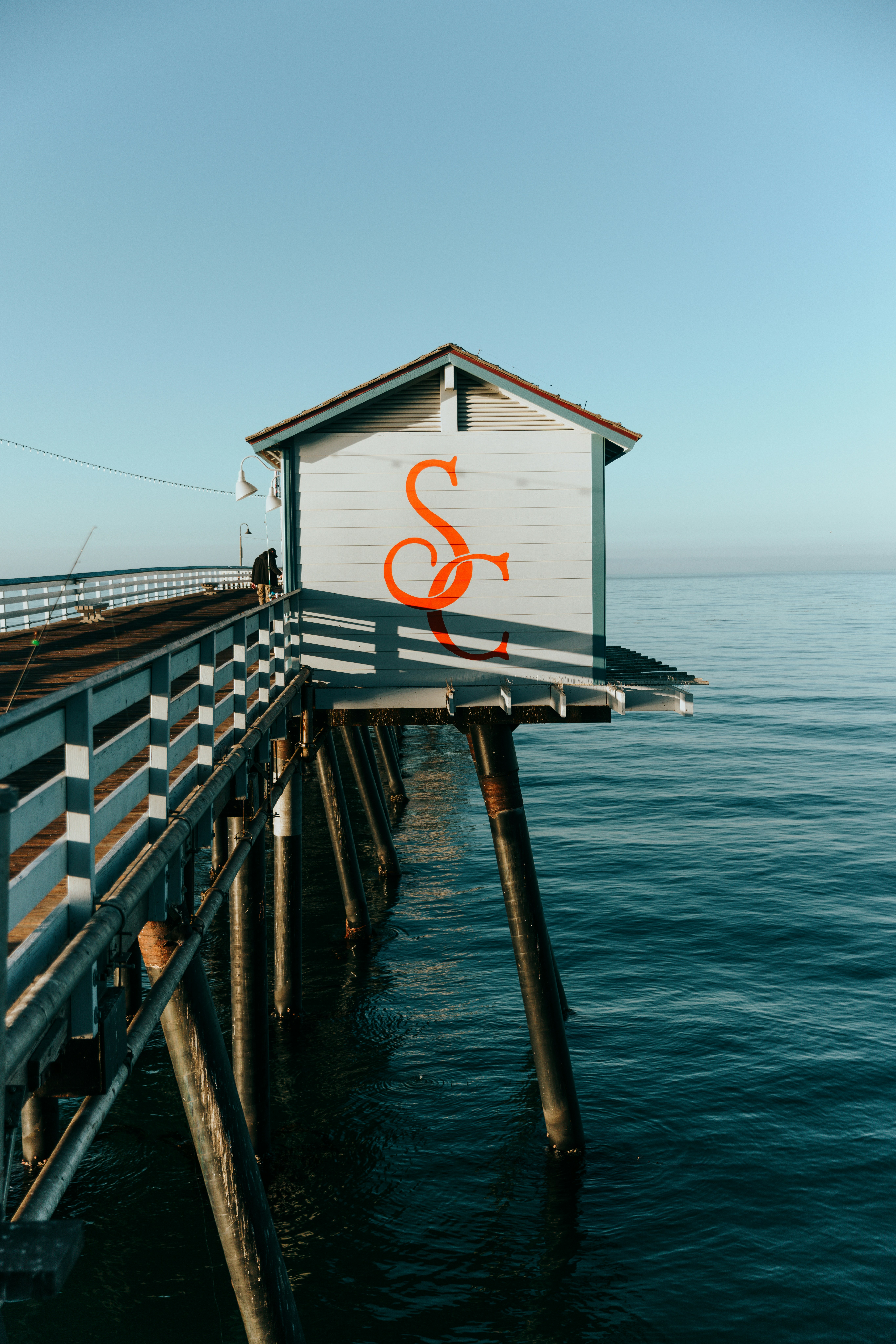 Pier House at Sea: The Orange S Script on a Quiet Horizon