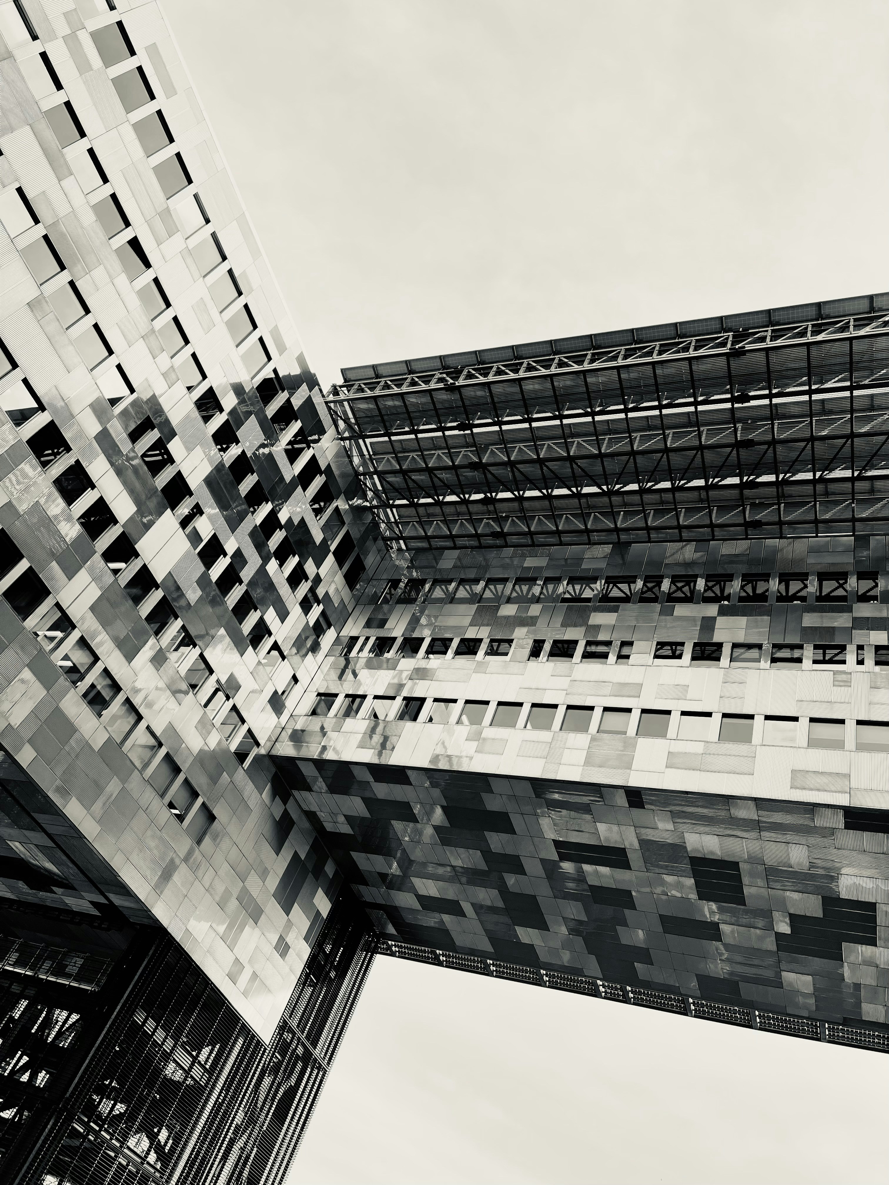 Abstract architectural structure with overlapping metallic panels and geometric patterns.