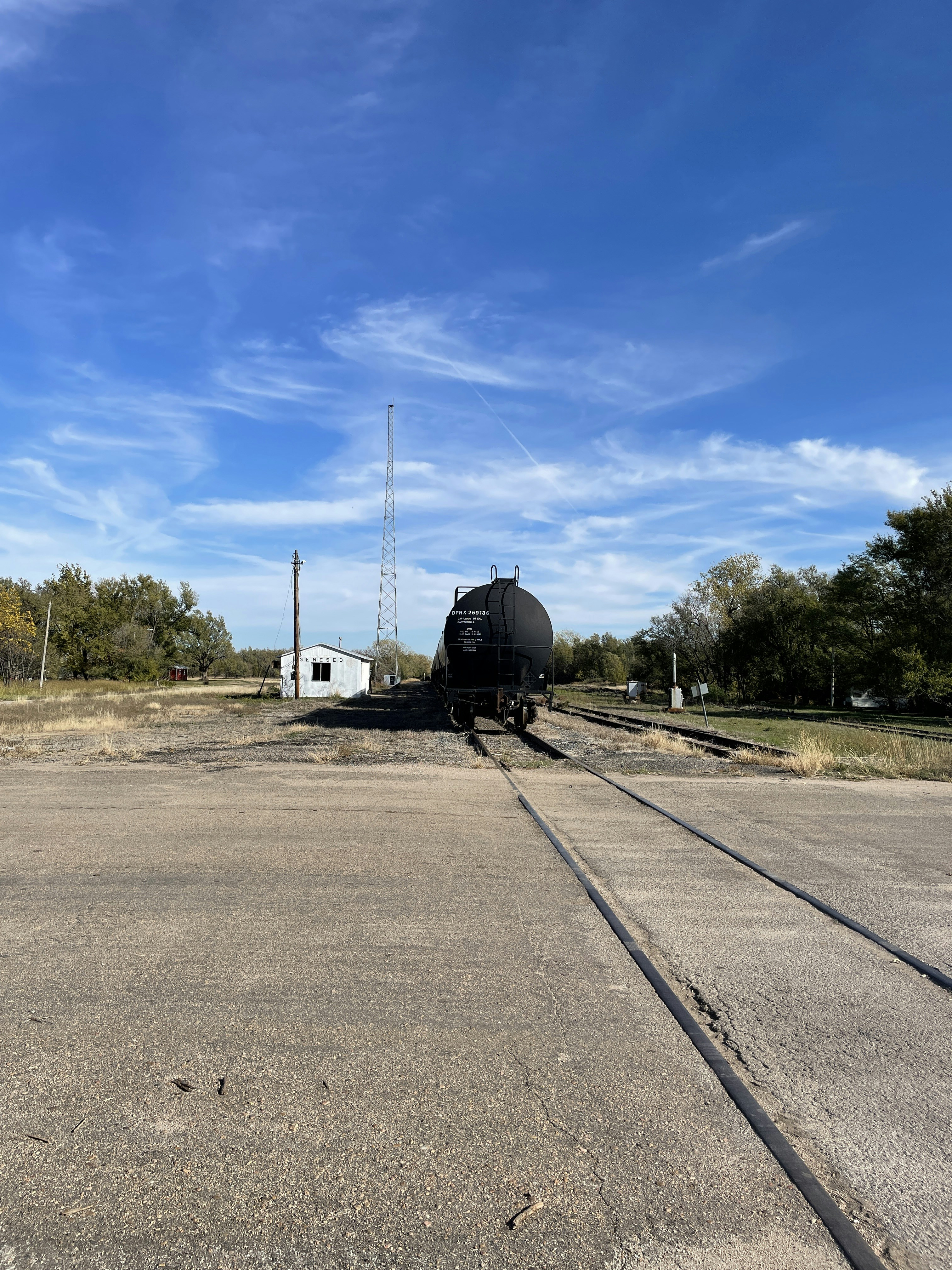 A train traveling down train tracks next to a field photo – Free Train ...