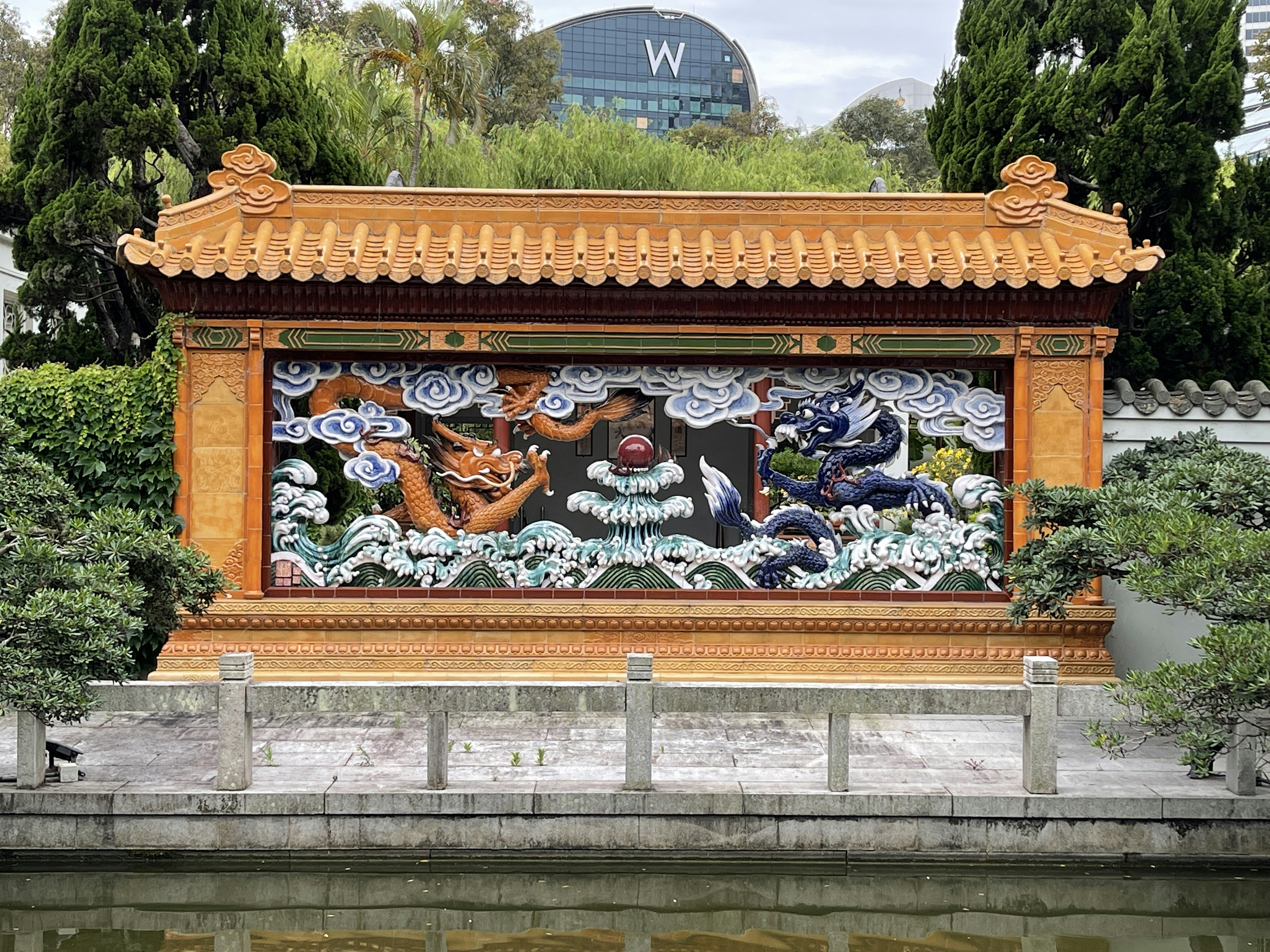 Dragon Gate by the Canal: An Ornate Orange Frame Framing a Wave-Woven Mural