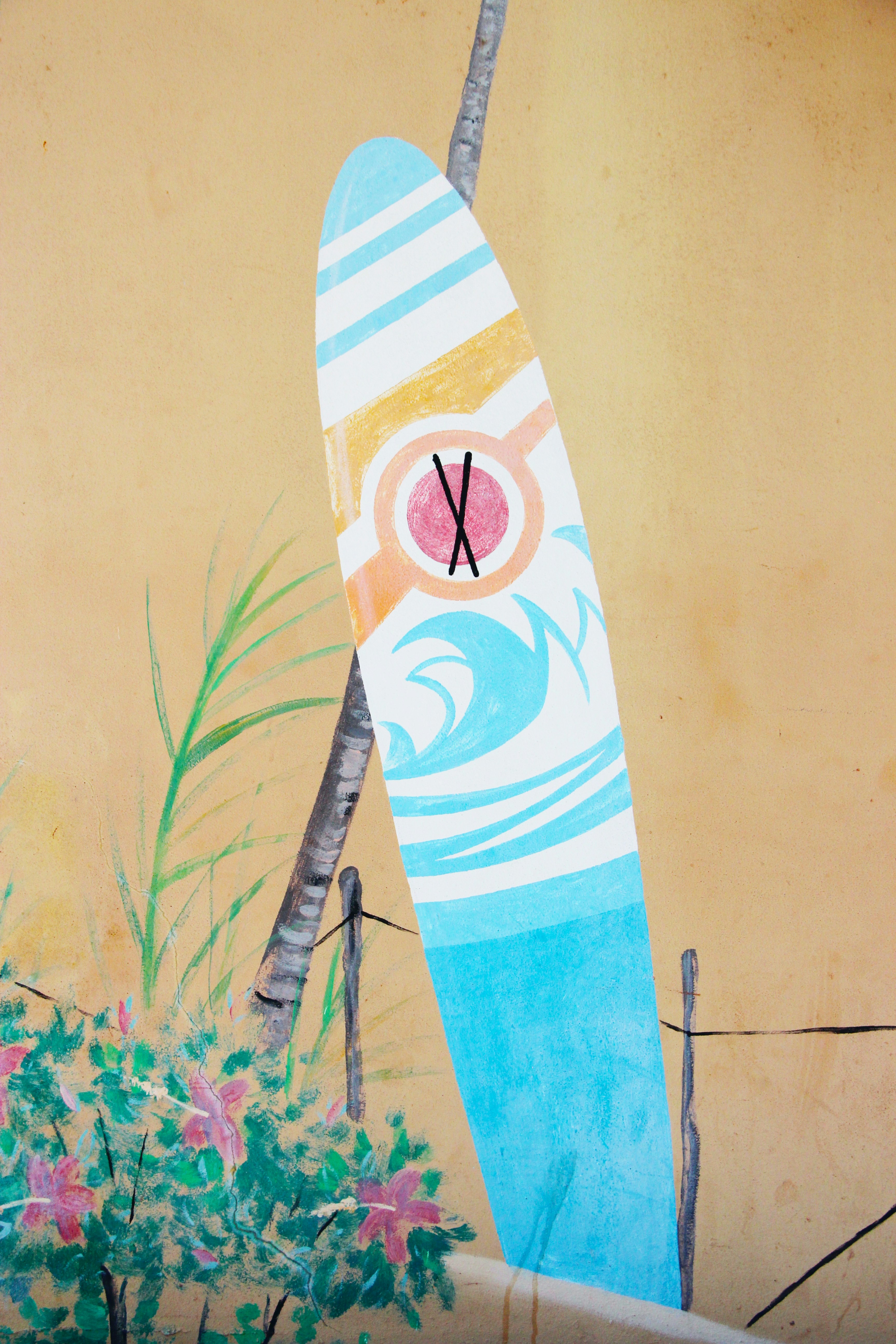 Pastel Surfboard Portrait on a Sunlit Wall
