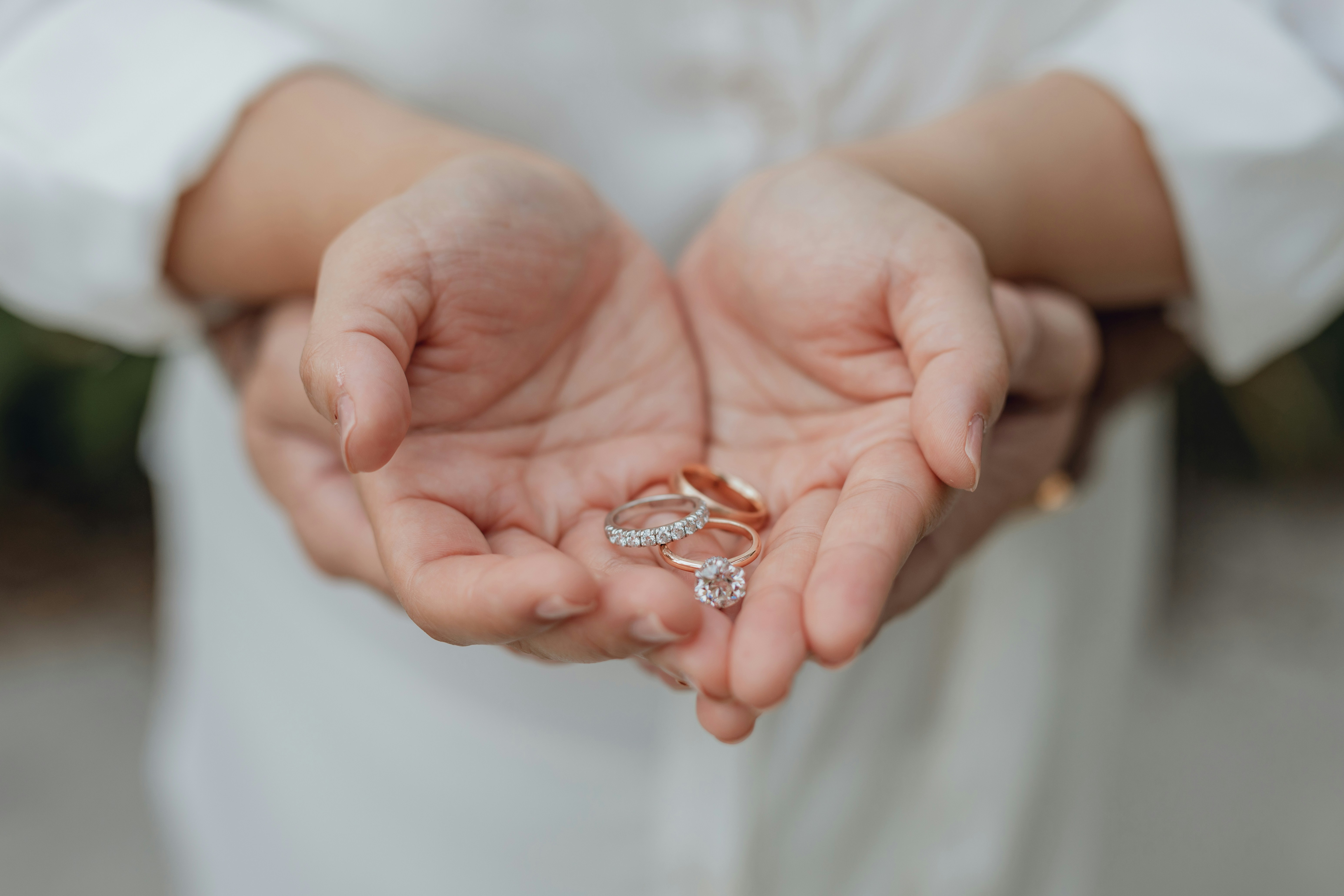 A woman holding two wedding rings in her hands photo – Free Maldives ...