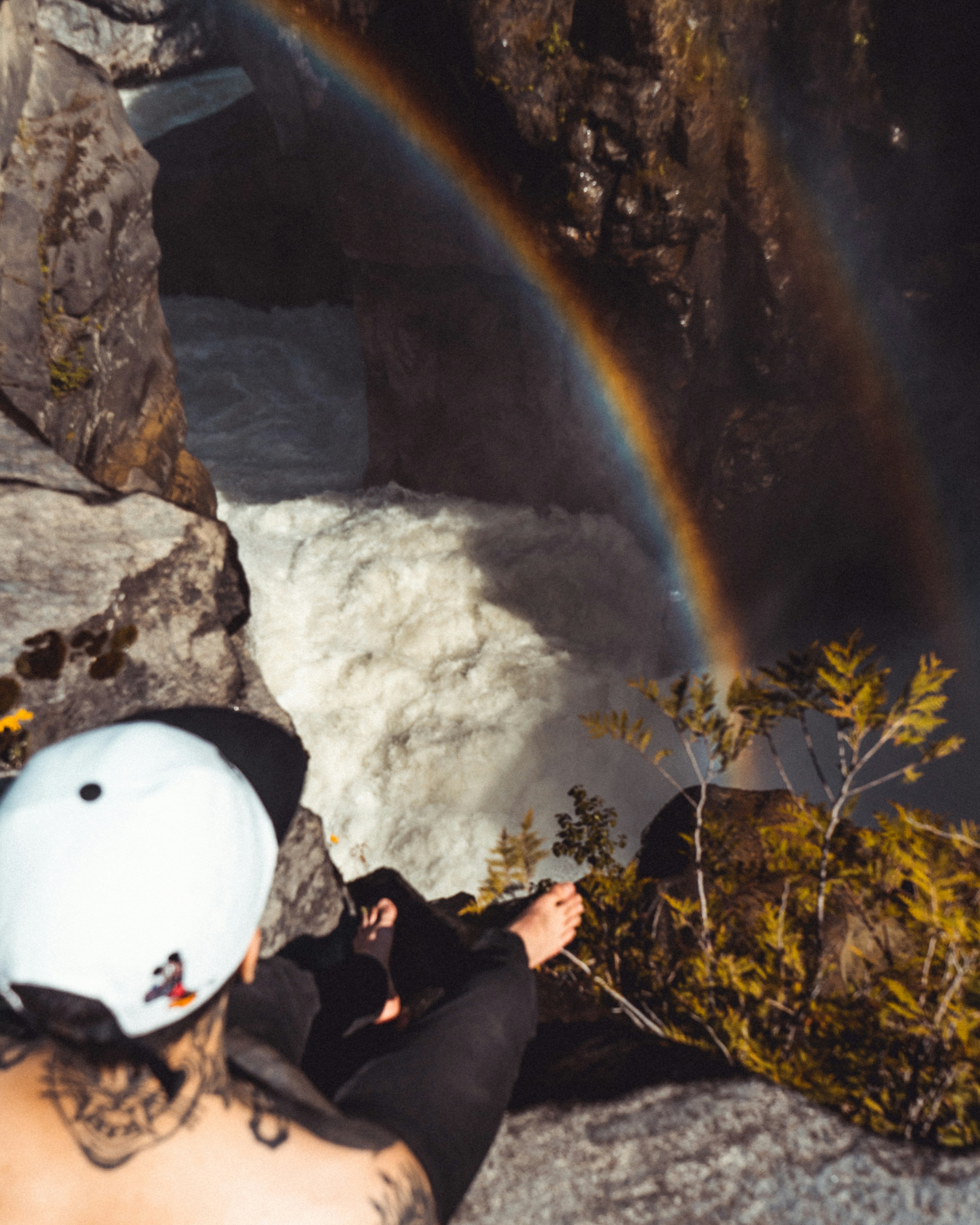 Rainbow at the Edge: A Sunset Streak Over the Falls