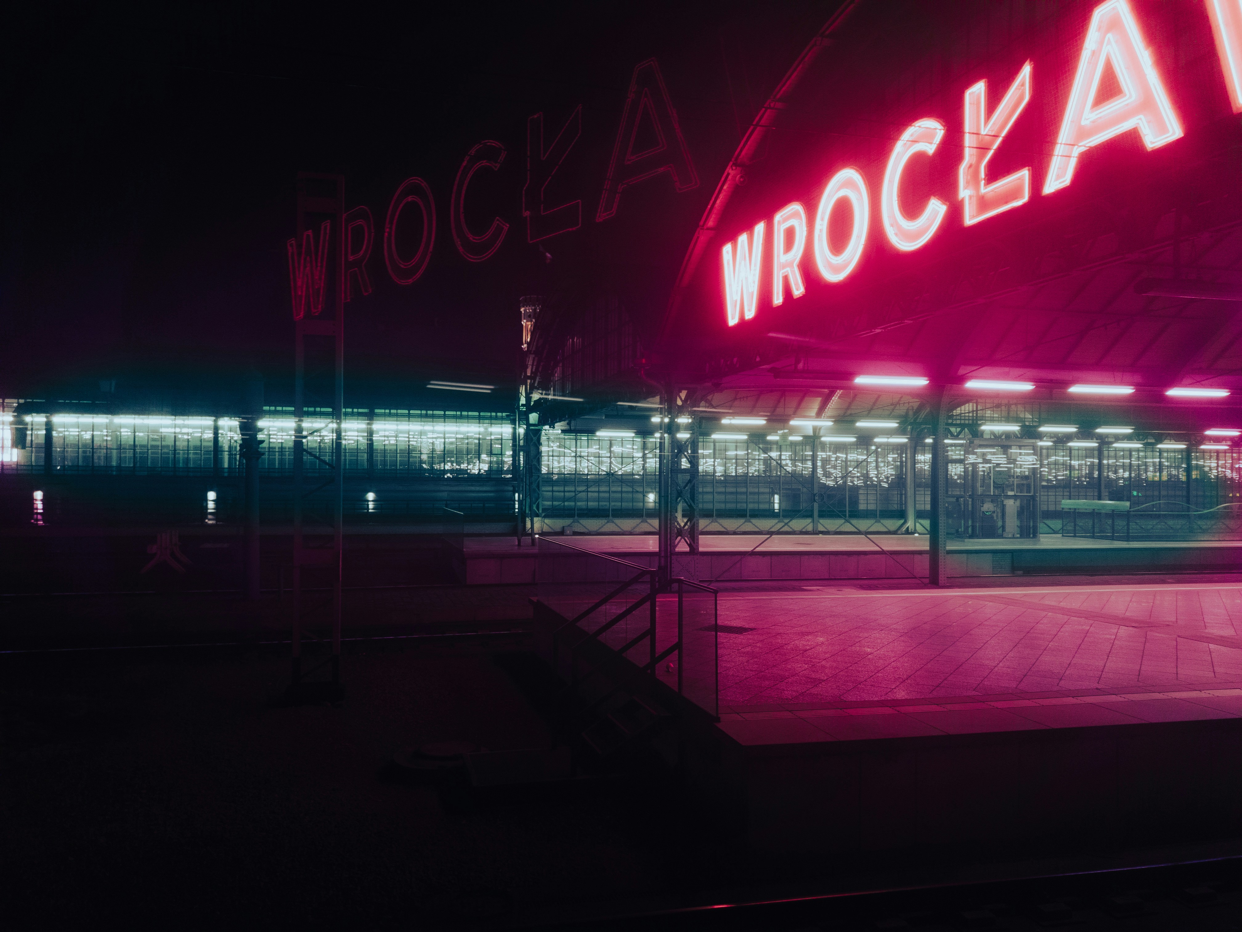 Wroclaw train station from the Nightjet | a large neon sign is lit up at night