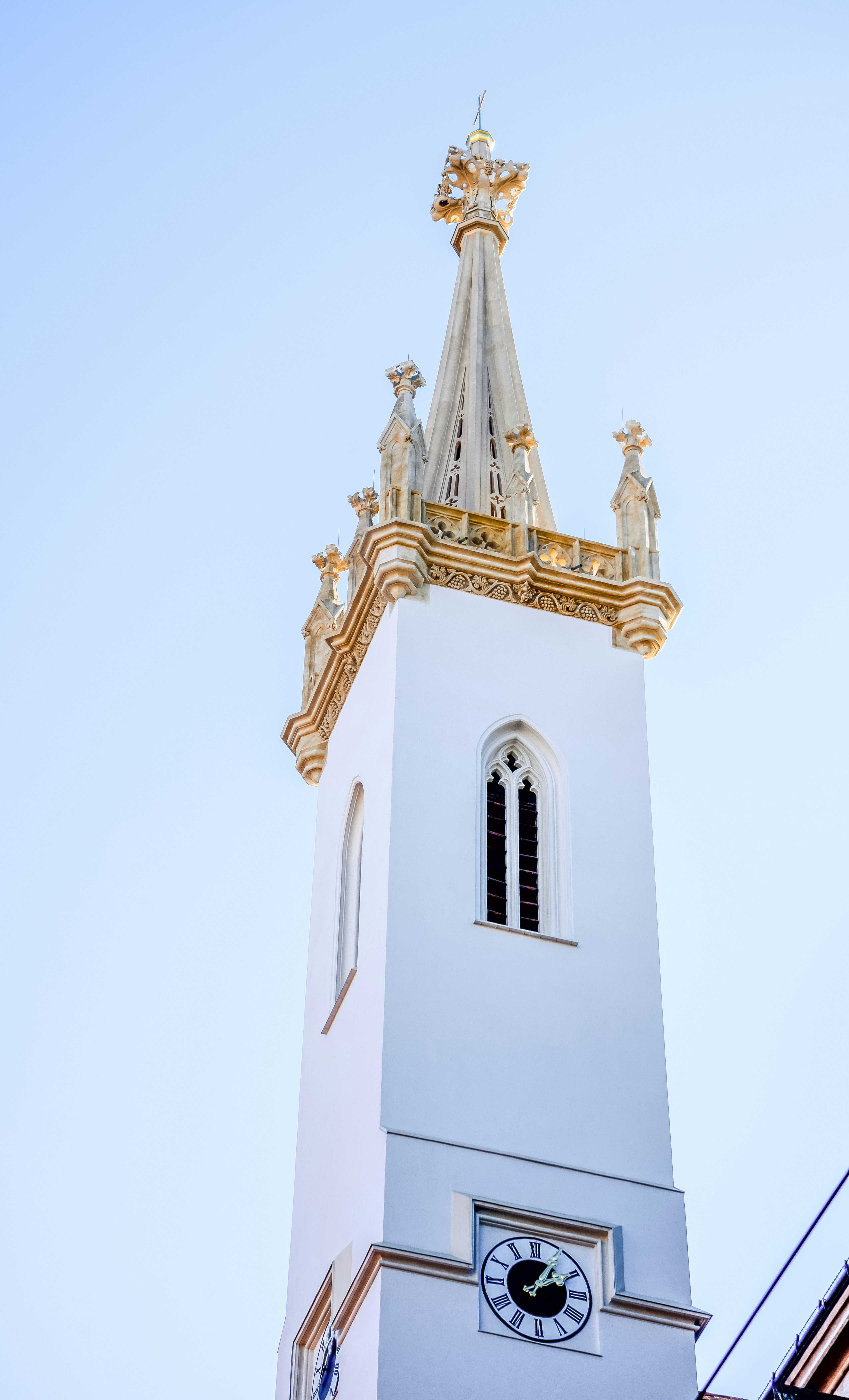 A tall white clock tower with a clock on each of it's sides photo ...