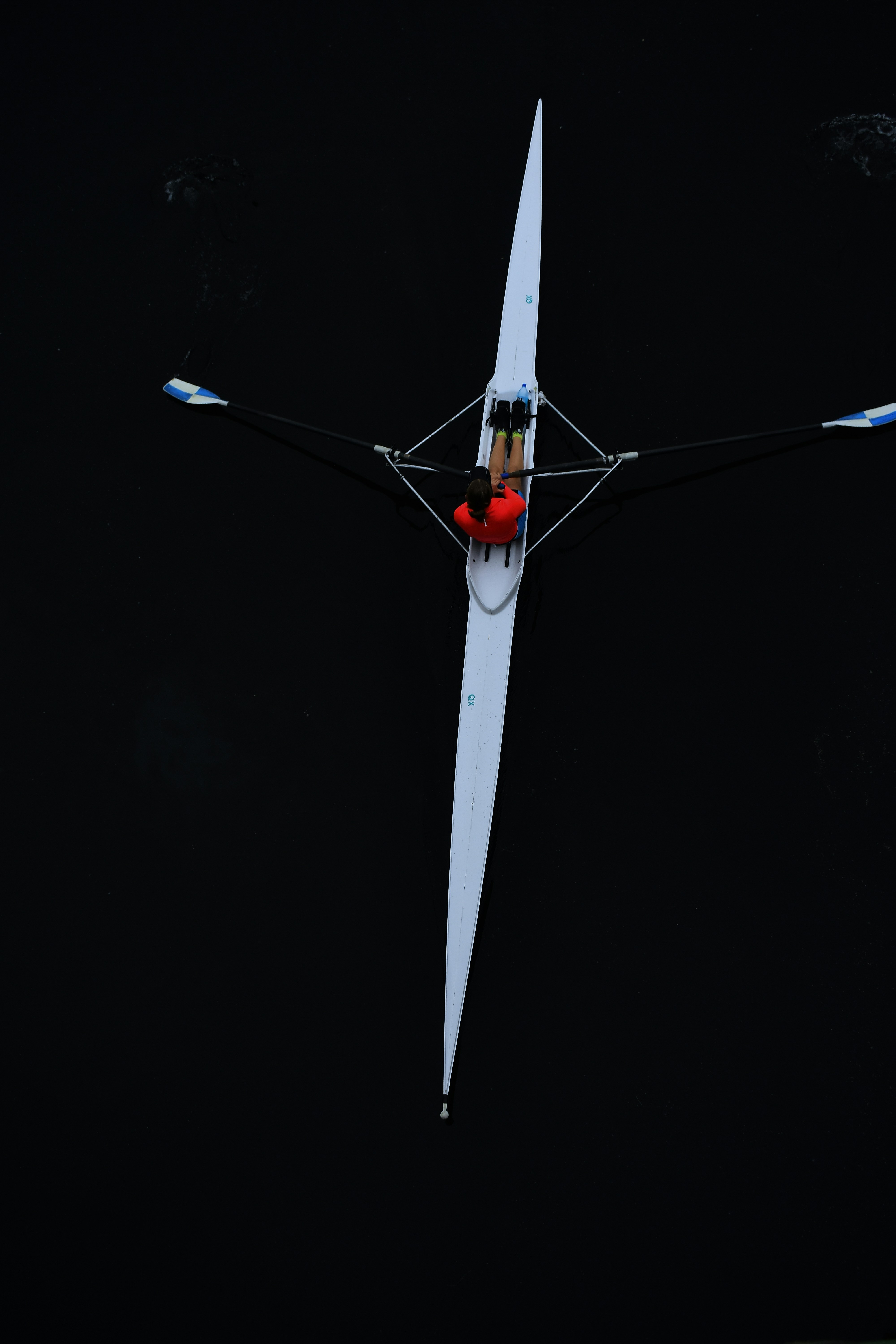 Midnight Scull from Above: Lone Rower on a White Shell