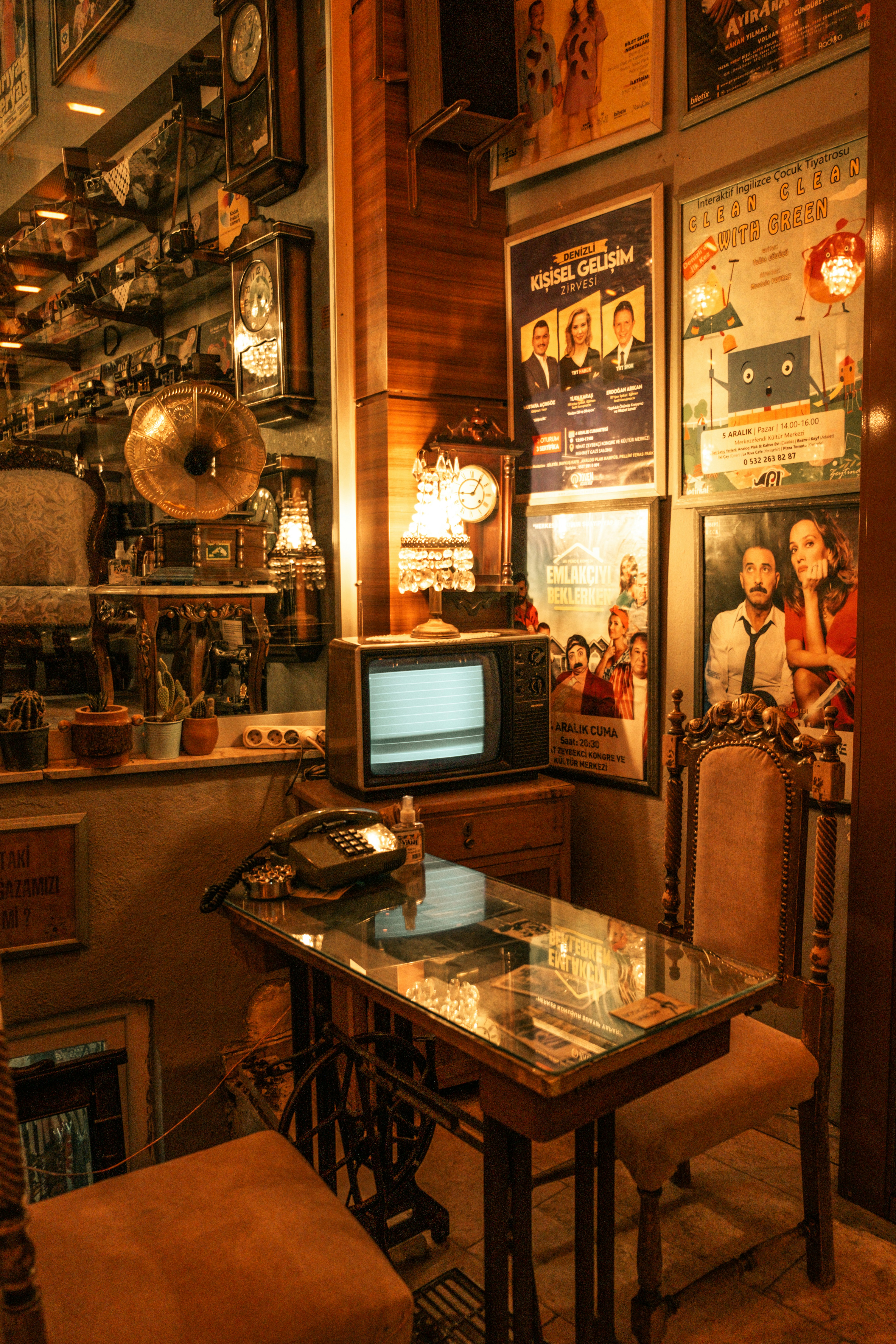 Vintage Nook of Light: CRT TV, Glass Table, and Poster Wall