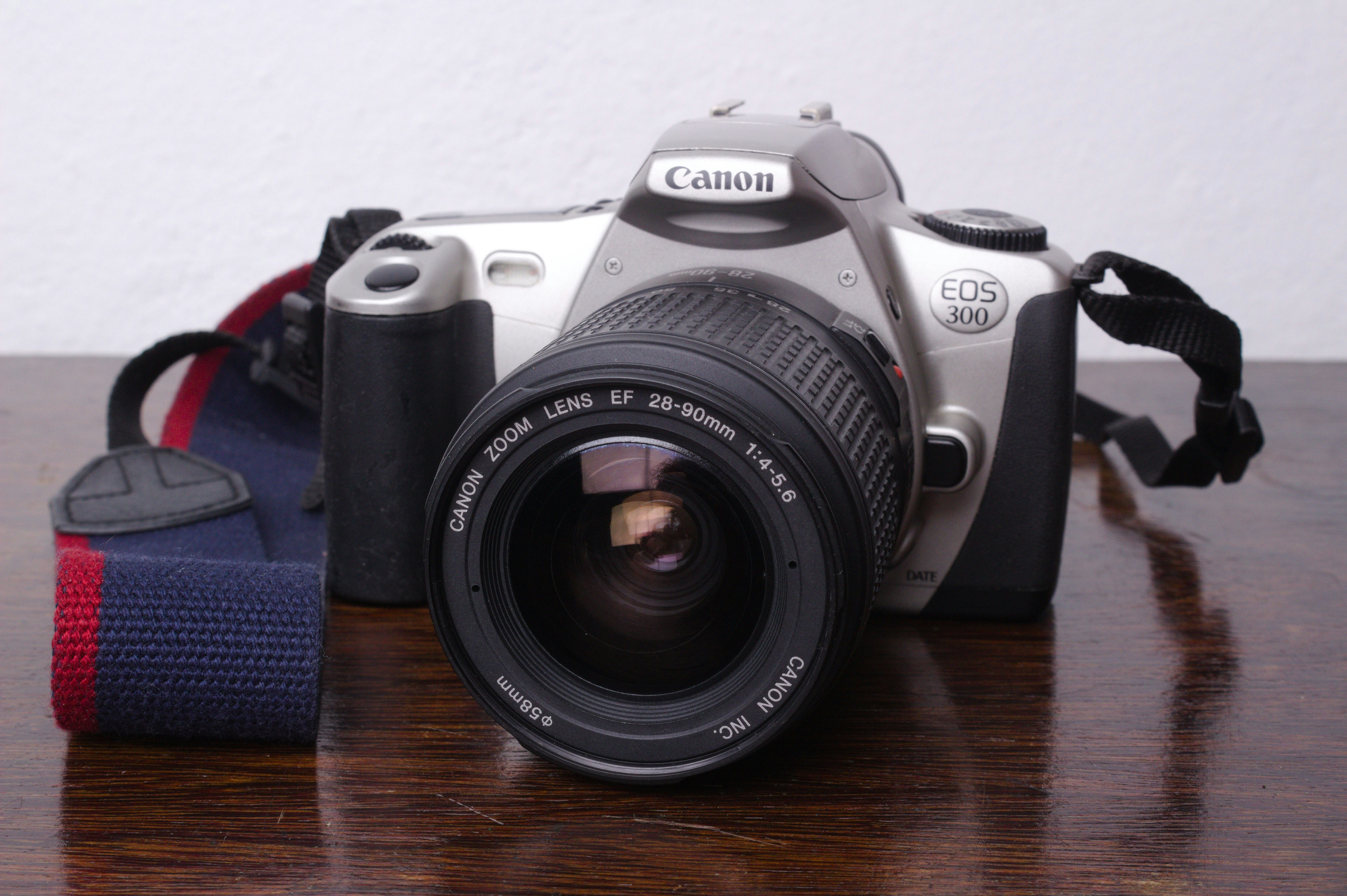Retro Canon EOS 300D Resting on a Polished Wooden Table, Lens Glistening