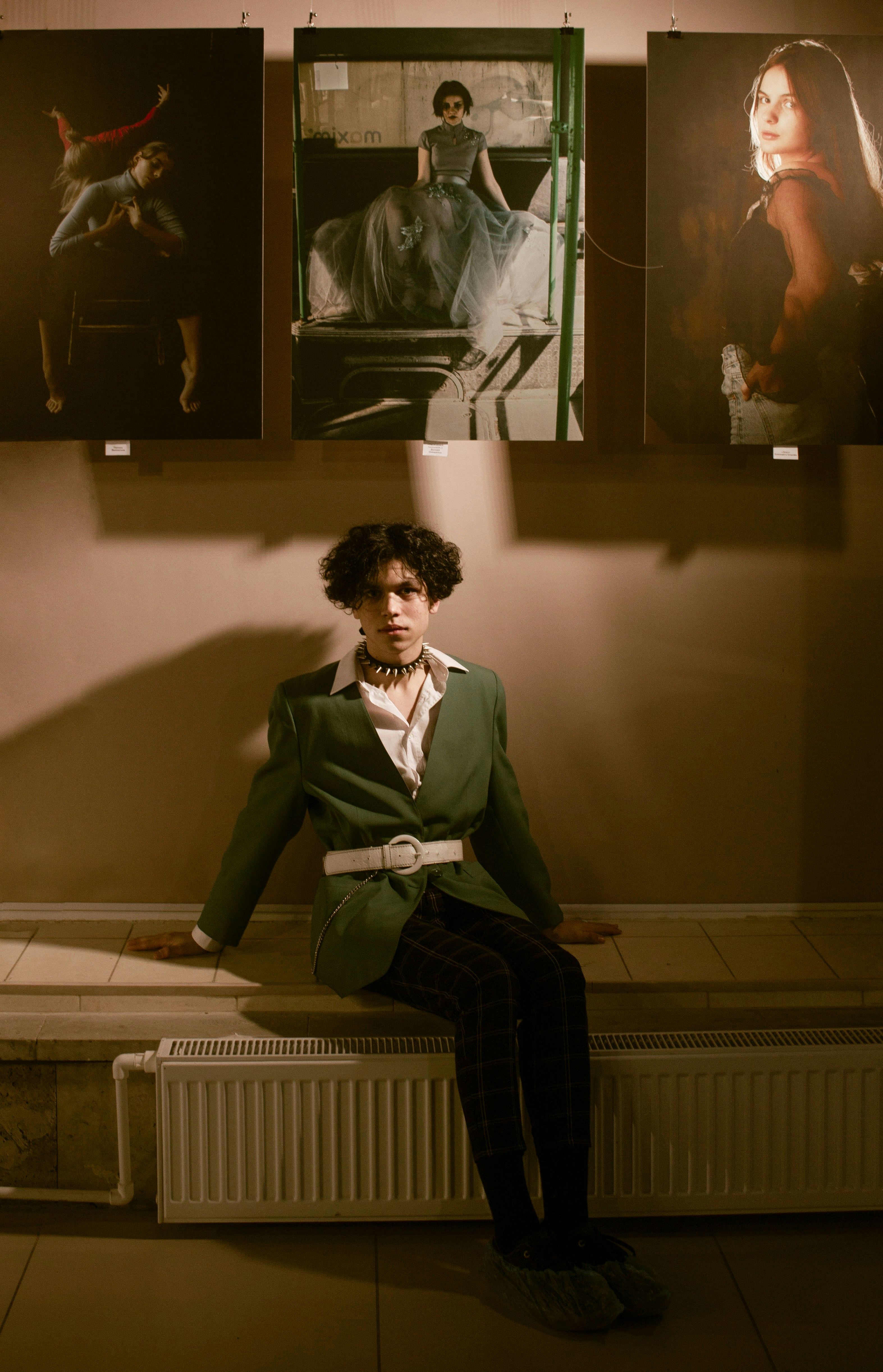 Emerald Silence: A Green-Jacketed Figure Anchored in a Portrait Gallery