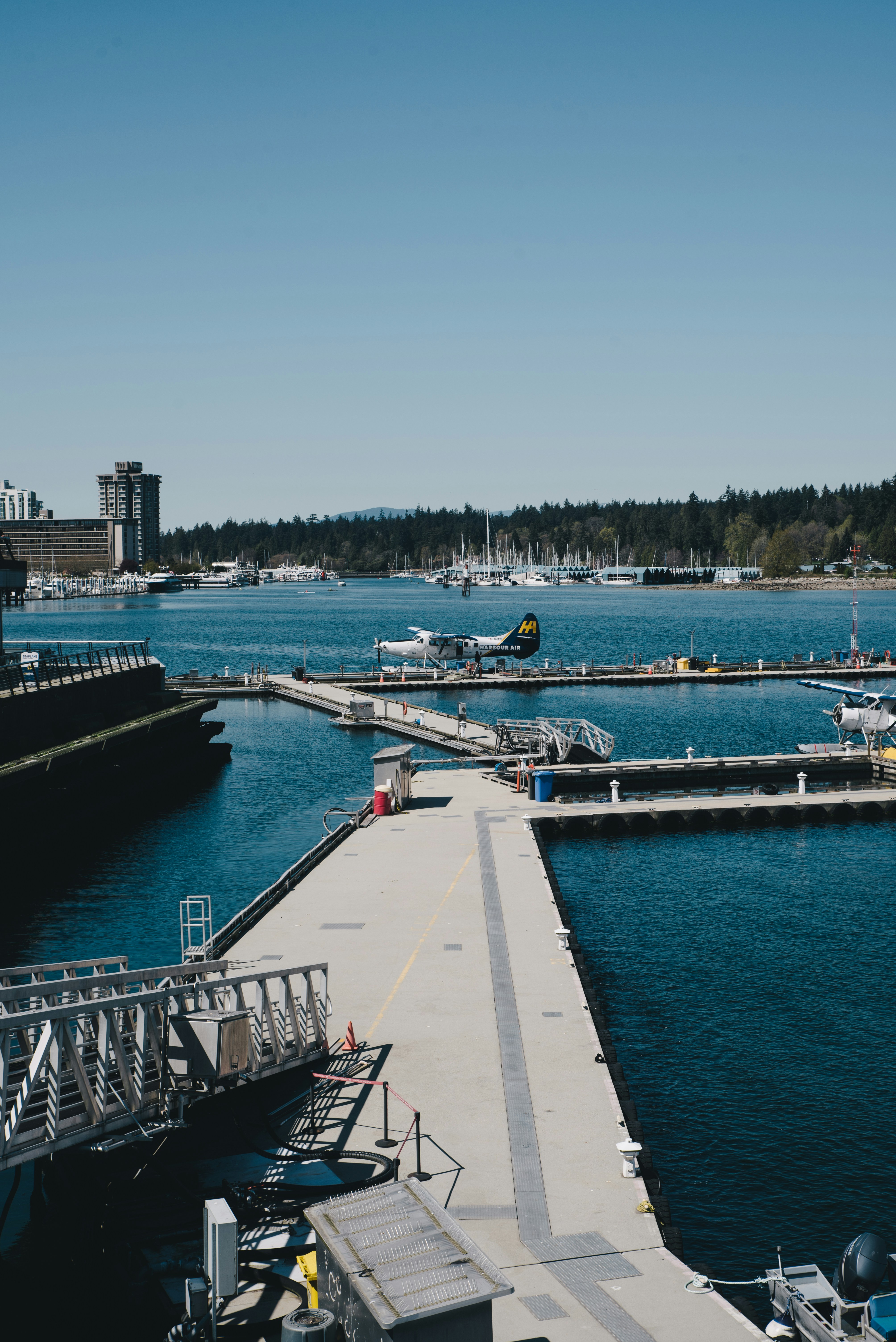A harbor with boats docked and a ramp leading to a dock photo – Free ...