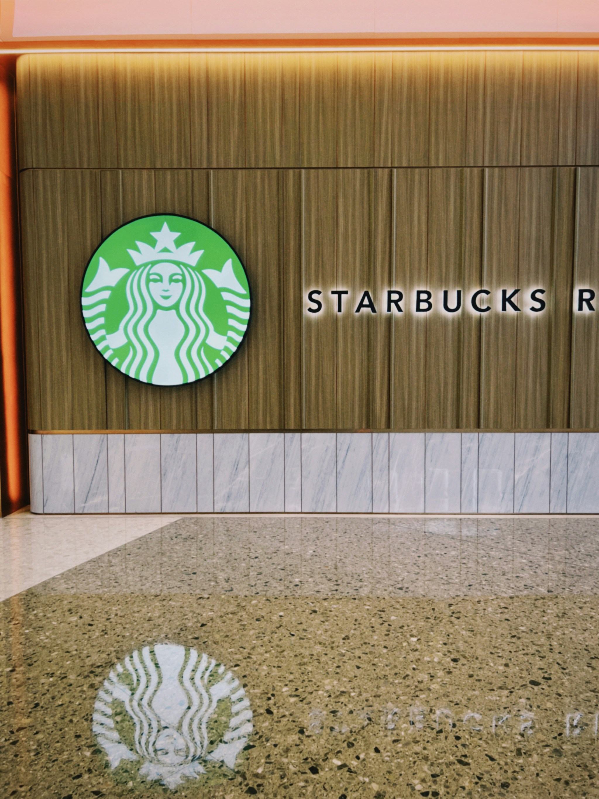 A starbucks sign on the side of a building photo – Free Furniture Image ...